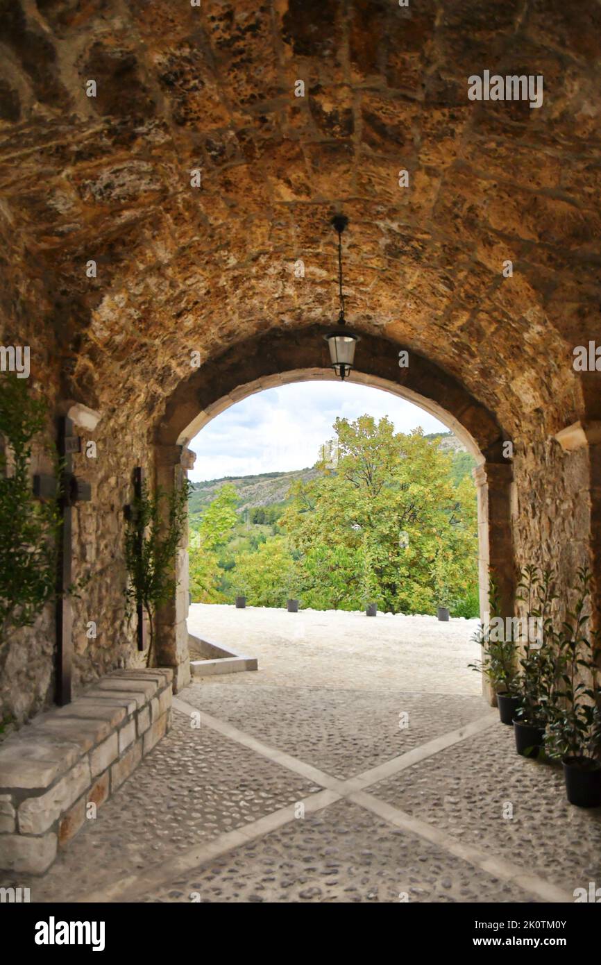 A narrow street between the old stone houses of Caramanico Terme, a ...