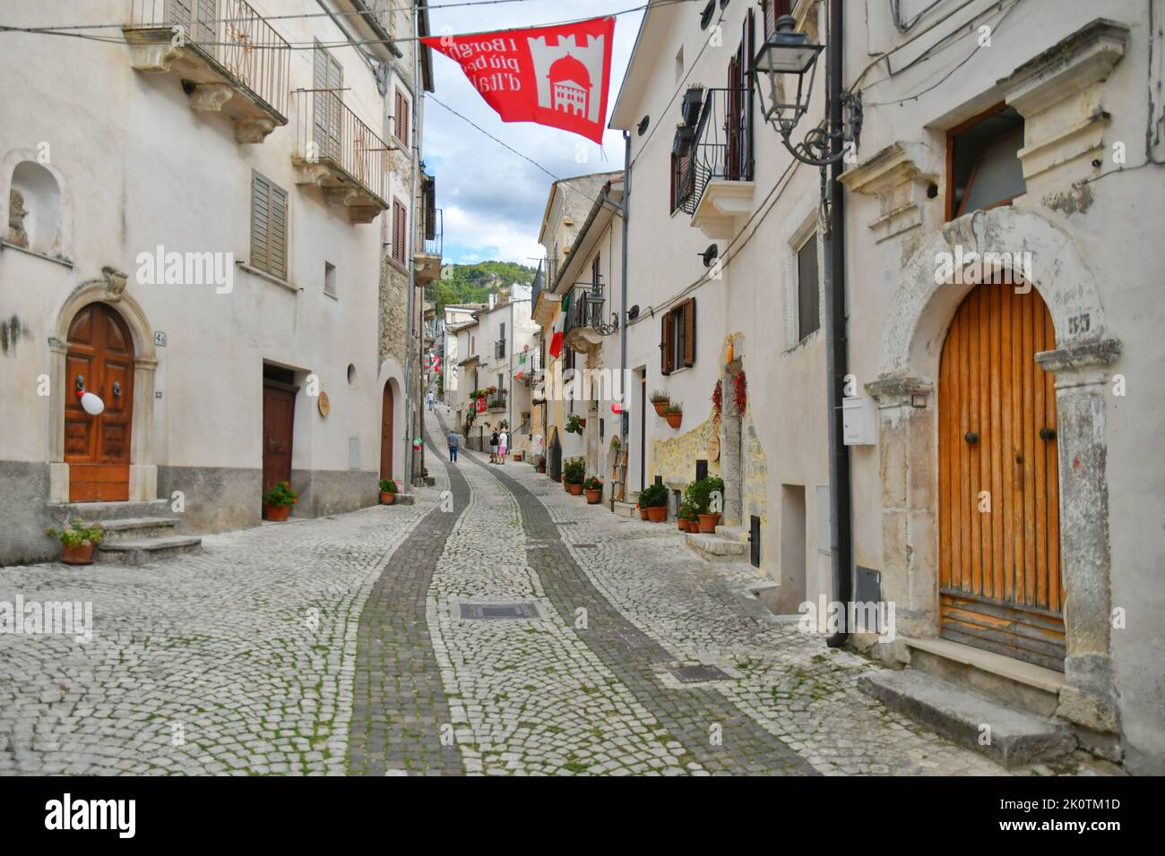 A narrow street between the old stone houses of Caramanico Terme, a ...