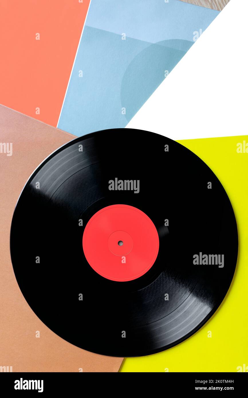 Composition of a vinyl record on colored covers. Top view. Space for ...