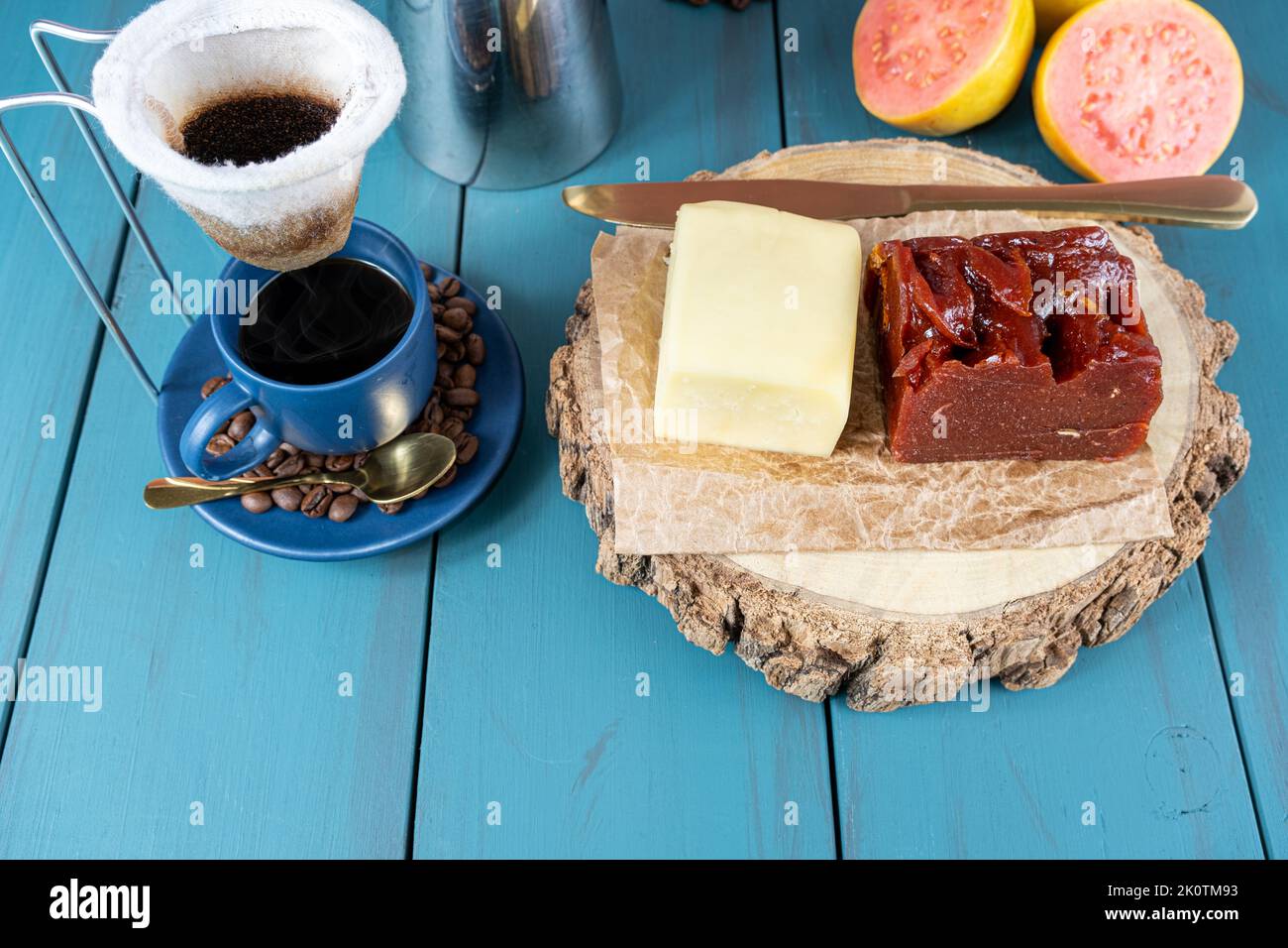 Closeup of guava sweet with cheese on a wooden board, next to a knife ...