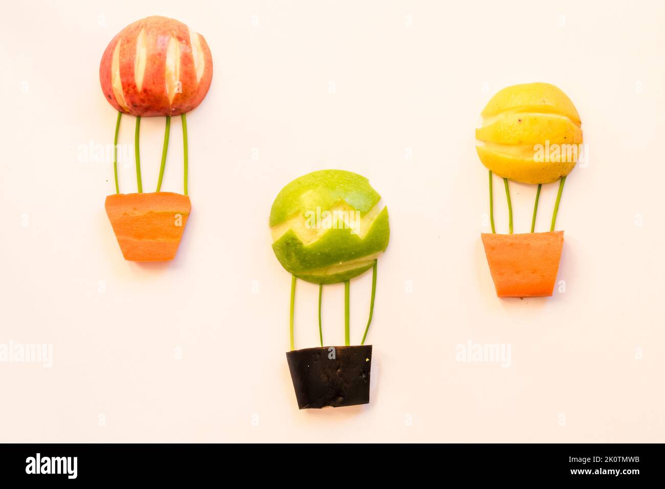 flying balloon made from apples and carrots, isolated colorful food ...