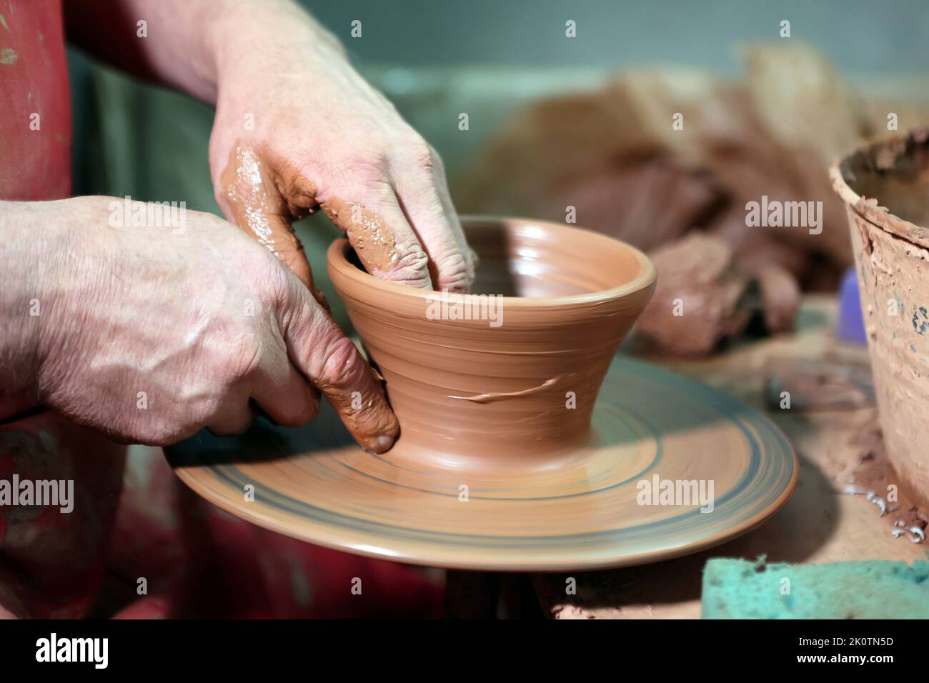 KOSIV, UKRAINE - SEPTEMBER 9, 2022 - A craftsman shapes a piece of clay ...
