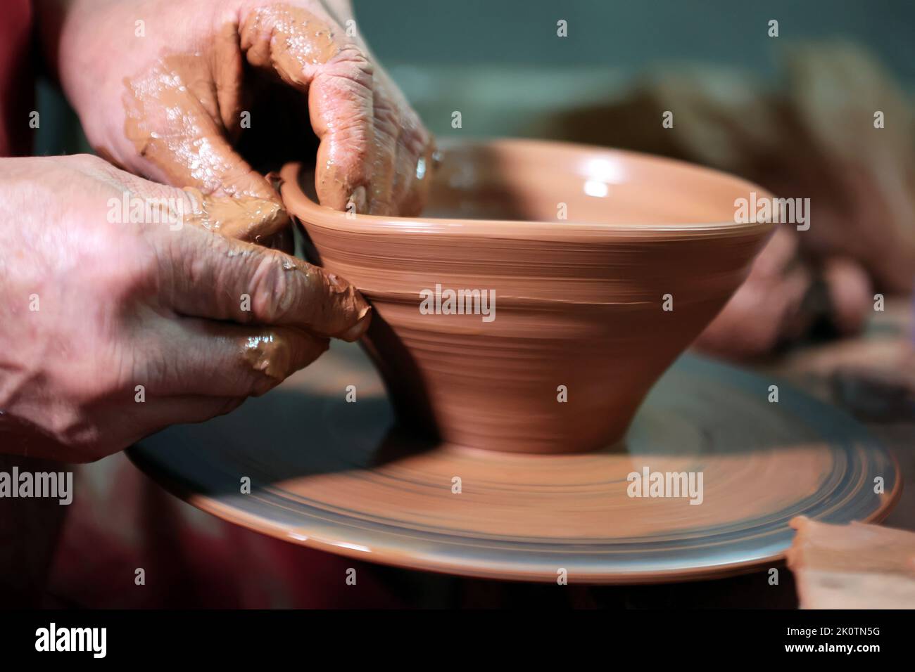 KOSIV, UKRAINE - SEPTEMBER 9, 2022 - A craftsman shapes a piece of clay ...