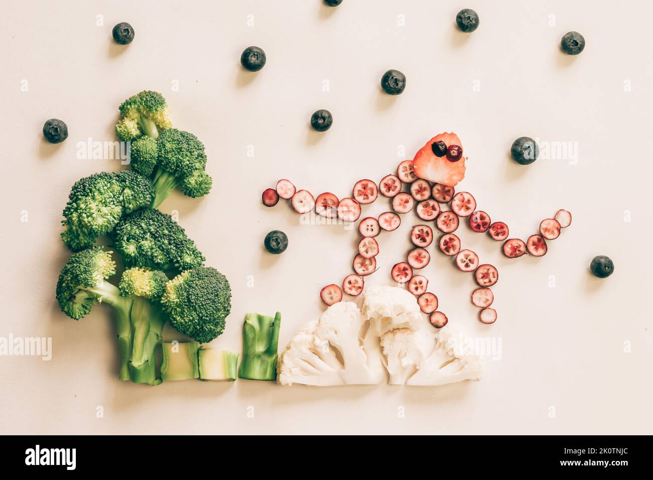 octopus made from red fruits with sea world from cauliflower, broccoli ...