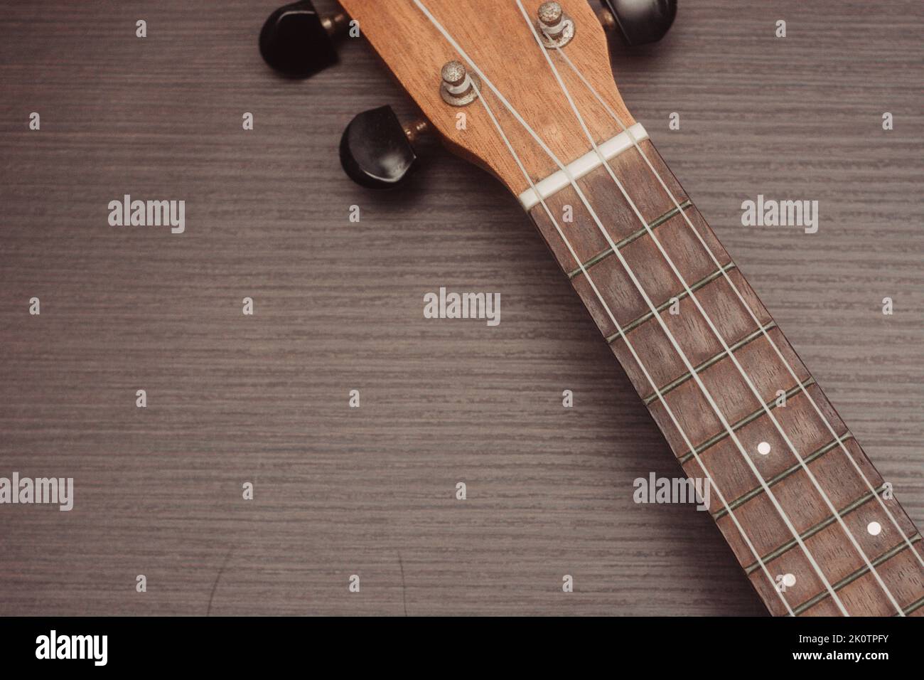 ukulele in close up with hand placing chords. The chord is G. Portable ...