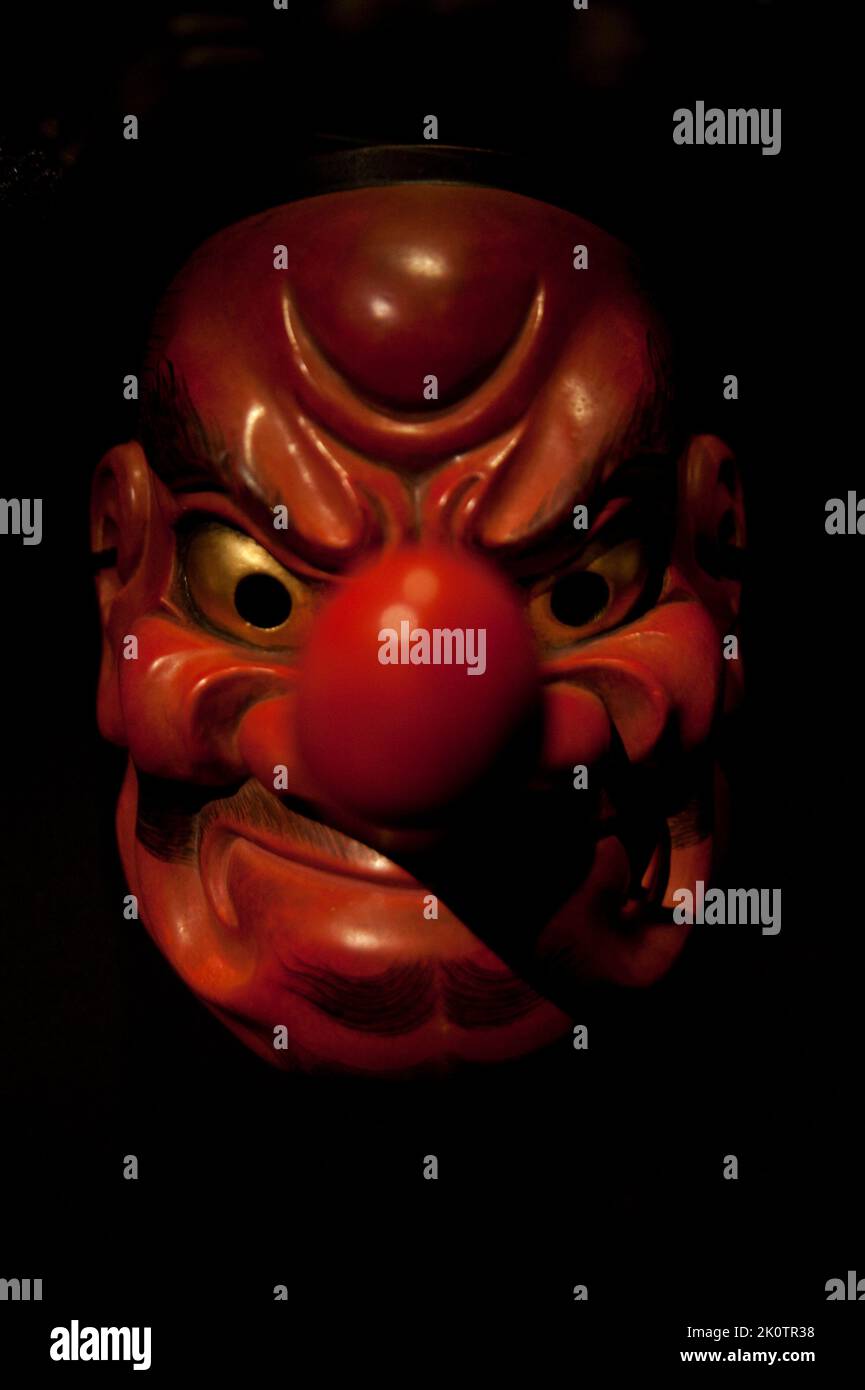 A vertical shot of a Japanese tengu mask used in Noh theatre isolated ...