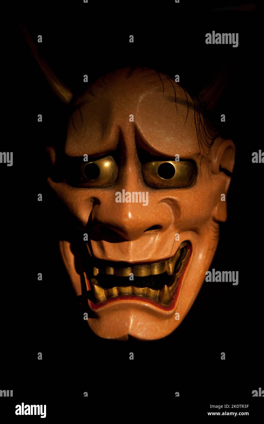 A vertical shot of a Japanese hannya mask used in Noh theatre isolated ...