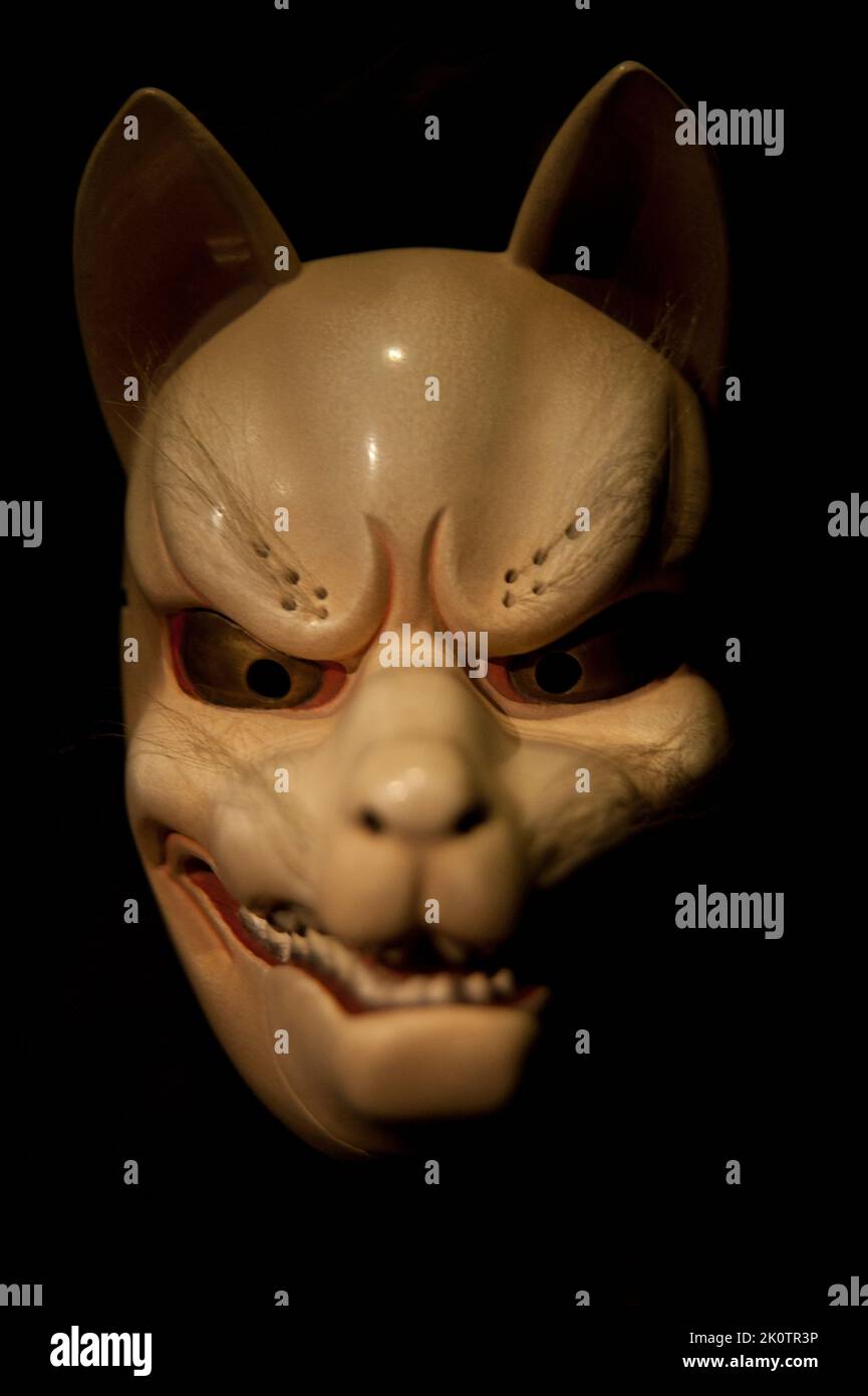 A vertical shot of a Japanese kitsune mask used in Noh theatre isolated ...