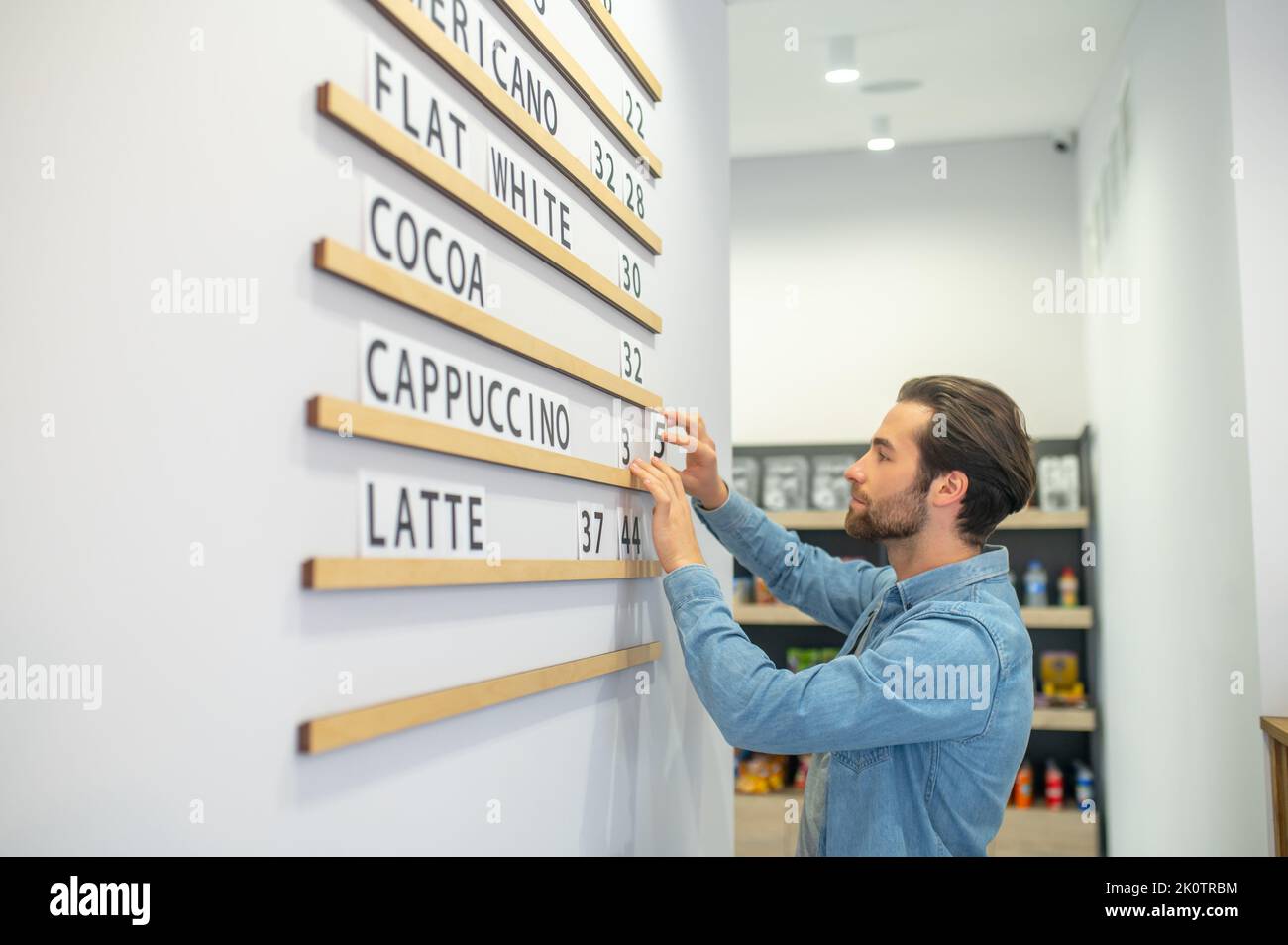 A cafe owner changing menu and lookin involved Stock Photo - Alamy