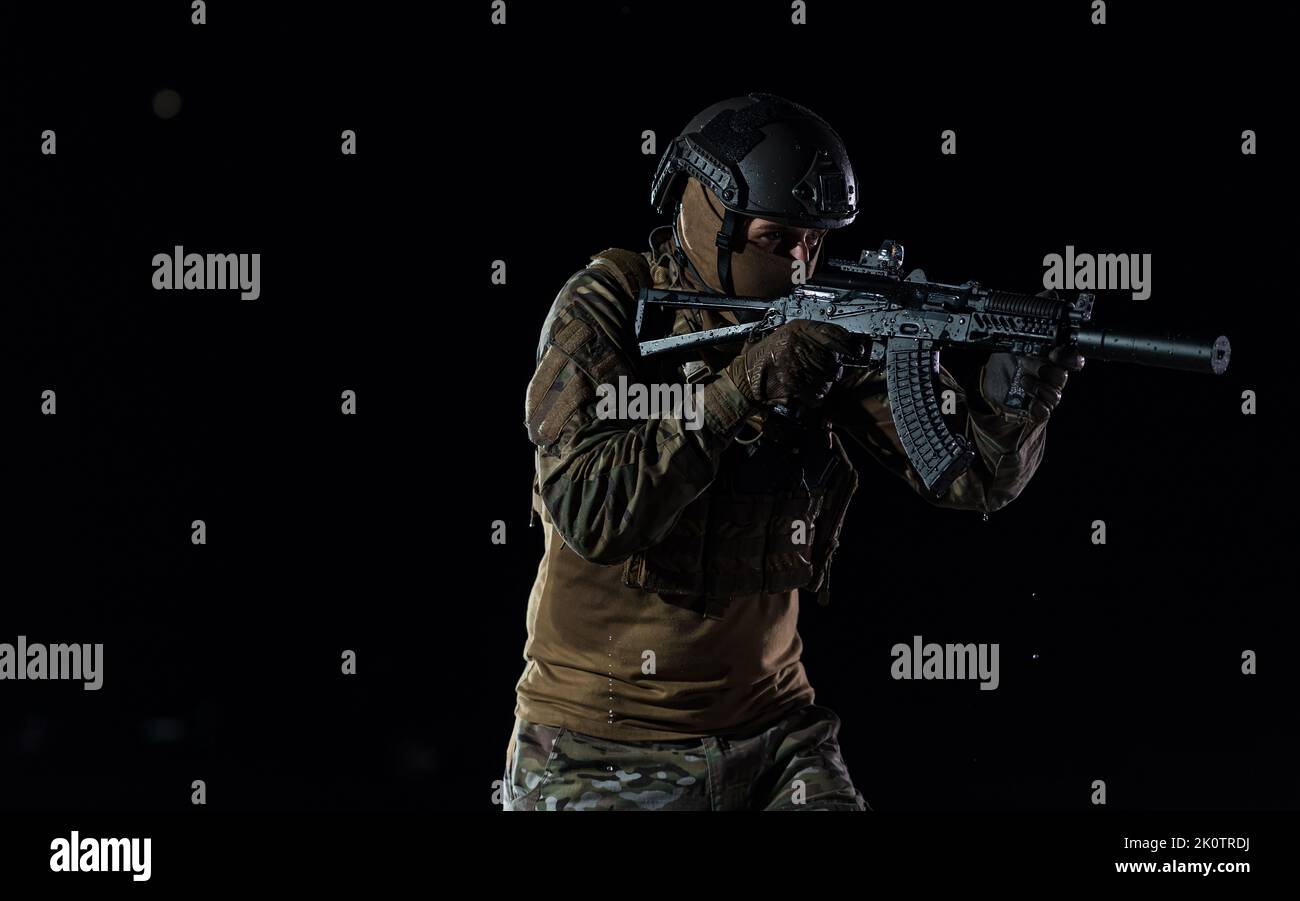 Army soldier in Combat Uniforms with an assault rifle, plate carrier ...