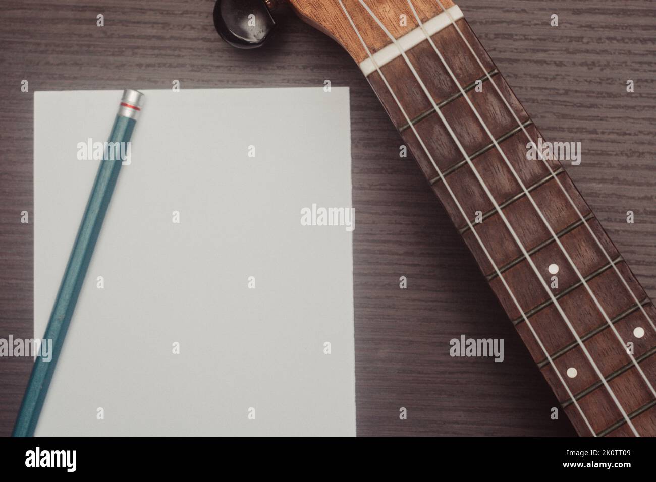 ukulele in close up with a sheet of paper to write down musical scores ...