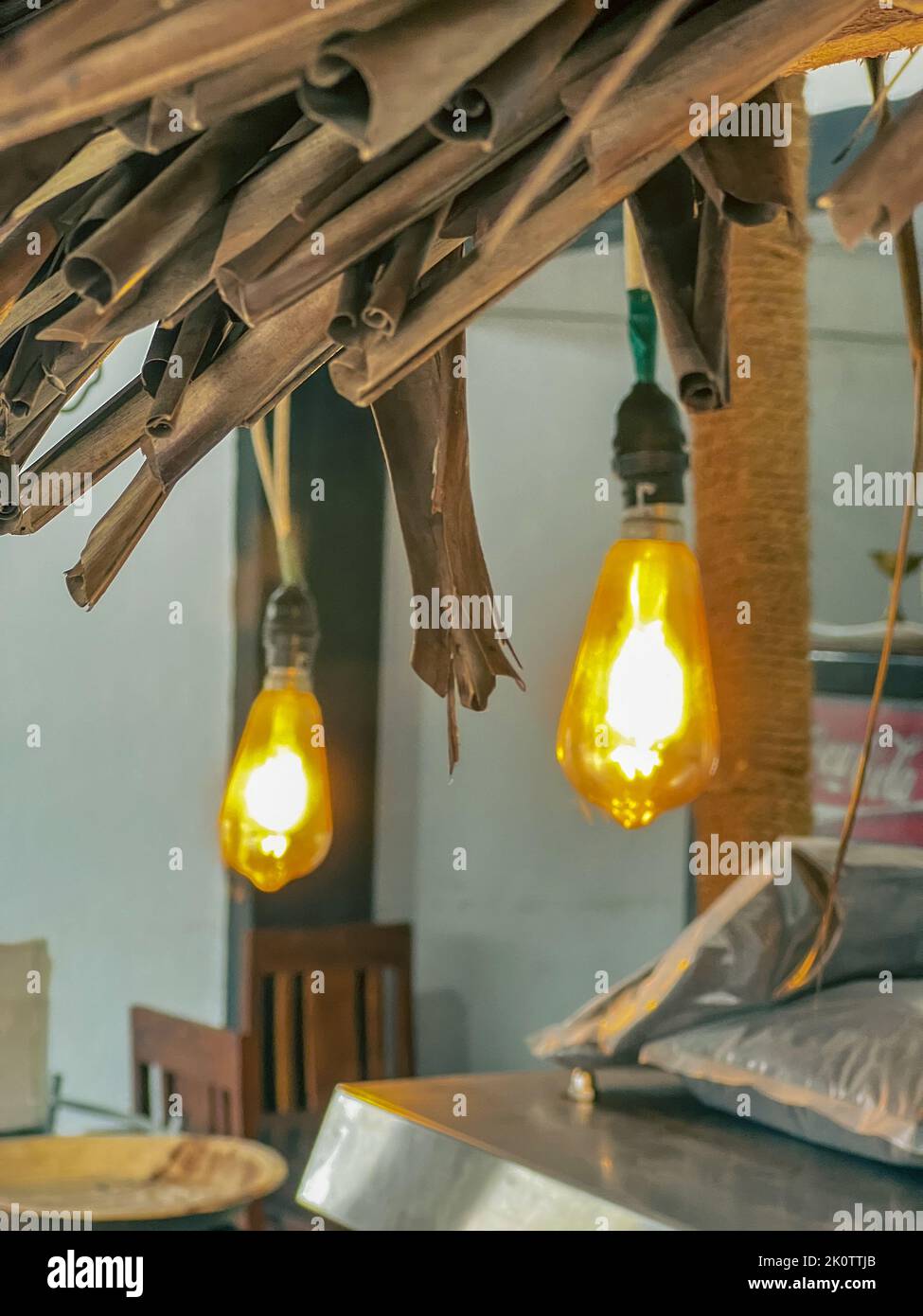 A vertical shot of light bulbs in an old hut Stock Photo - Alamy