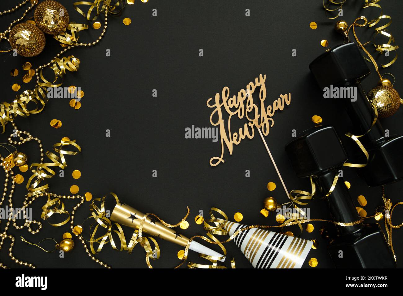 Gym dumbbells, golden decorations, confetti for New Year's Eve ...