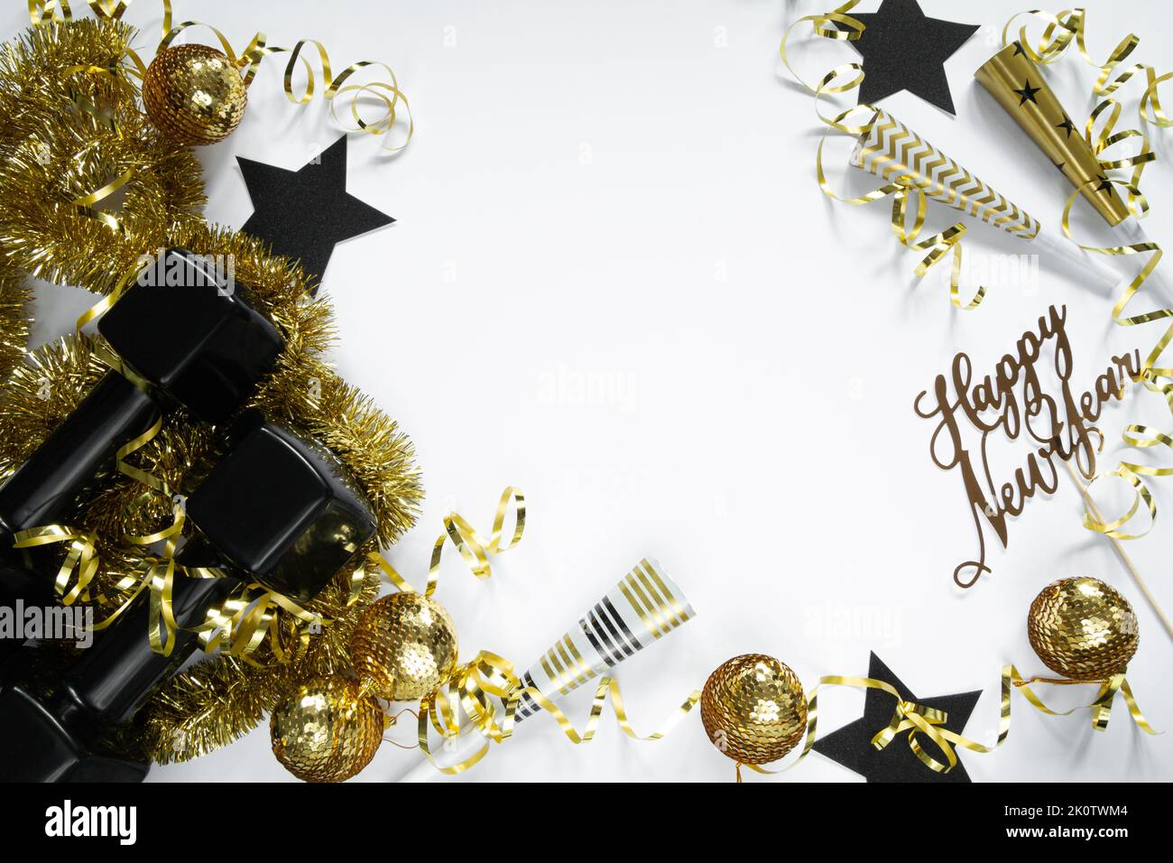 Gym dumbbells, golden decorations, confetti for New Year's Eve ...