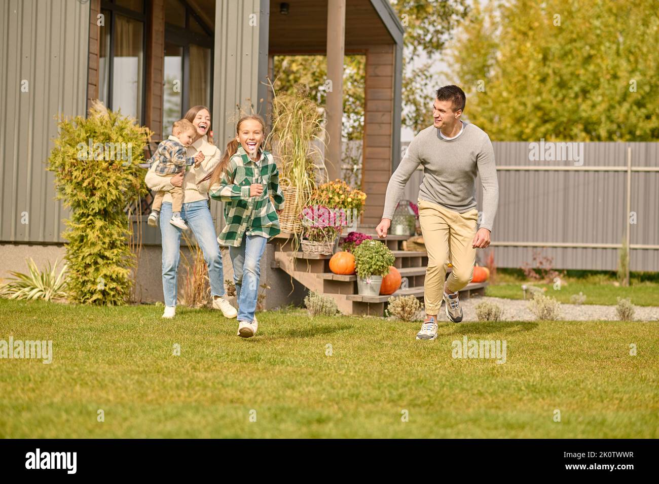 Family of four people having fun outdoors Stock Photo - Alamy