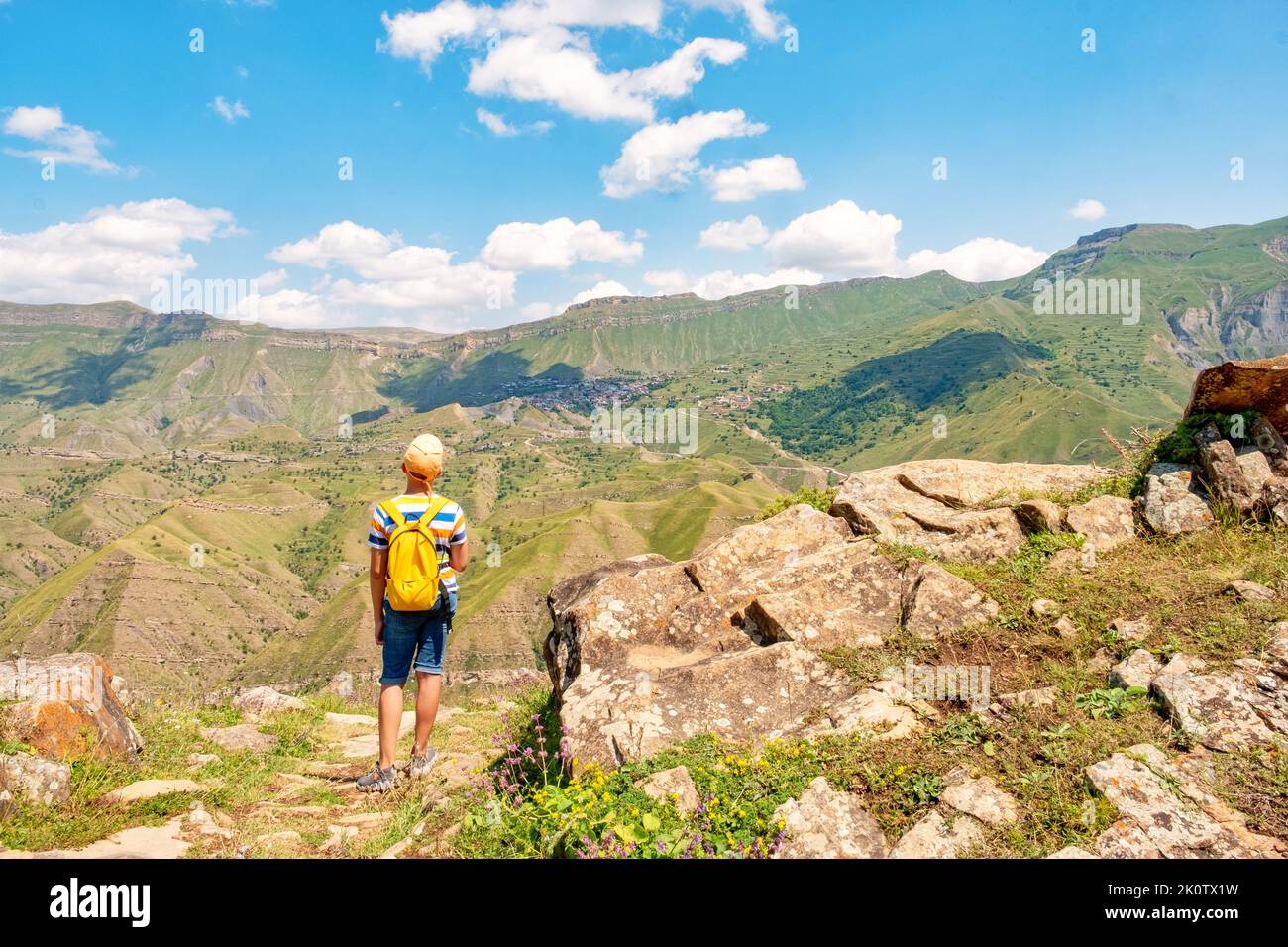 Traveler Teenager boy hands raised mountains landscape Stock Photo - Alamy