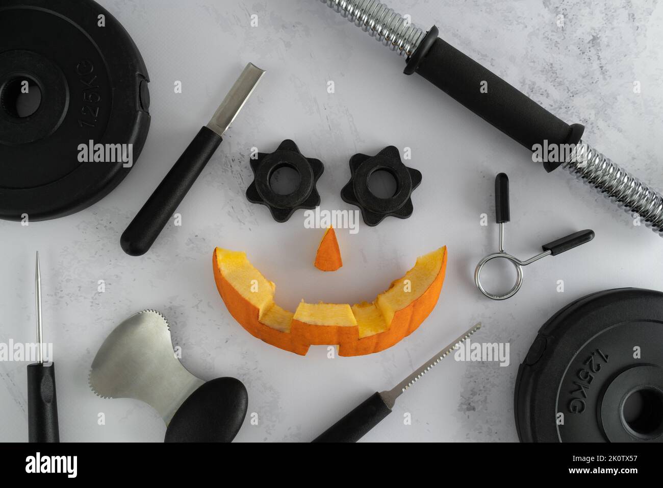 Gym dumbbell barbell weight plate with Halloween pumpkin pieces cut out ...