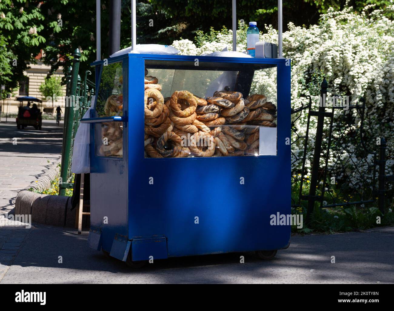 Street vendor cart selling Krakowskie Obwarzanki in Krakow Poland. Kraków Booth stall with ...