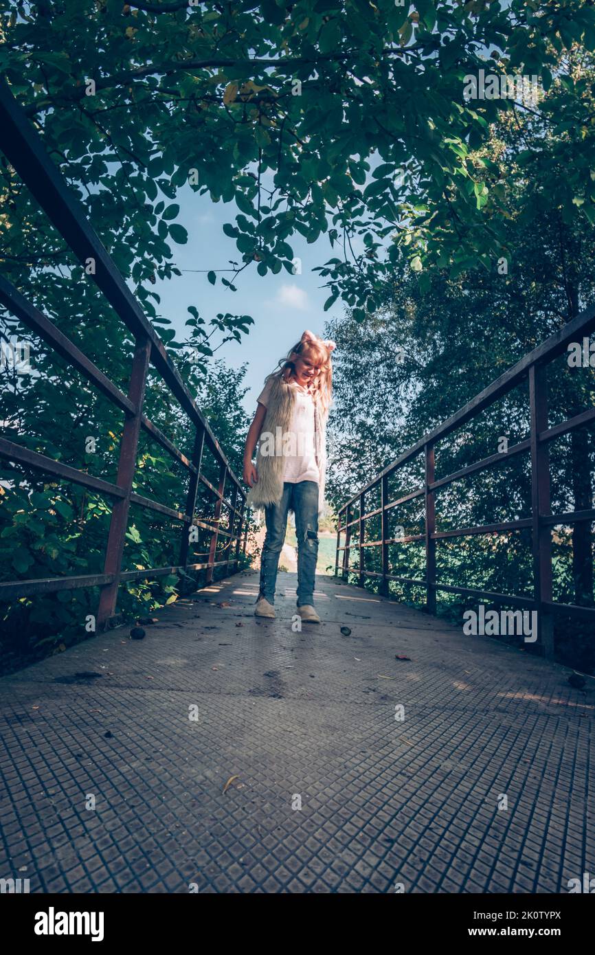 cute teenage girl standing in the bridge Stock Photo - Alamy