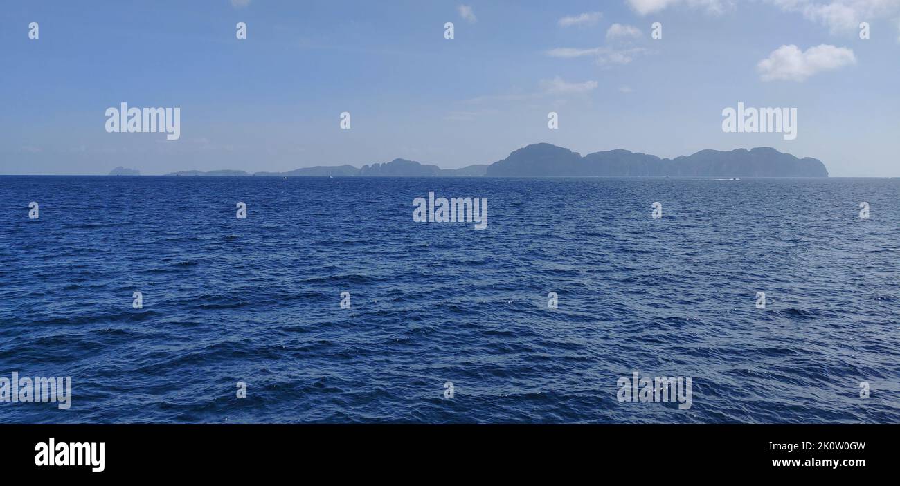 An aerial panoramic view of a beautiful island with cliffs covered in ...