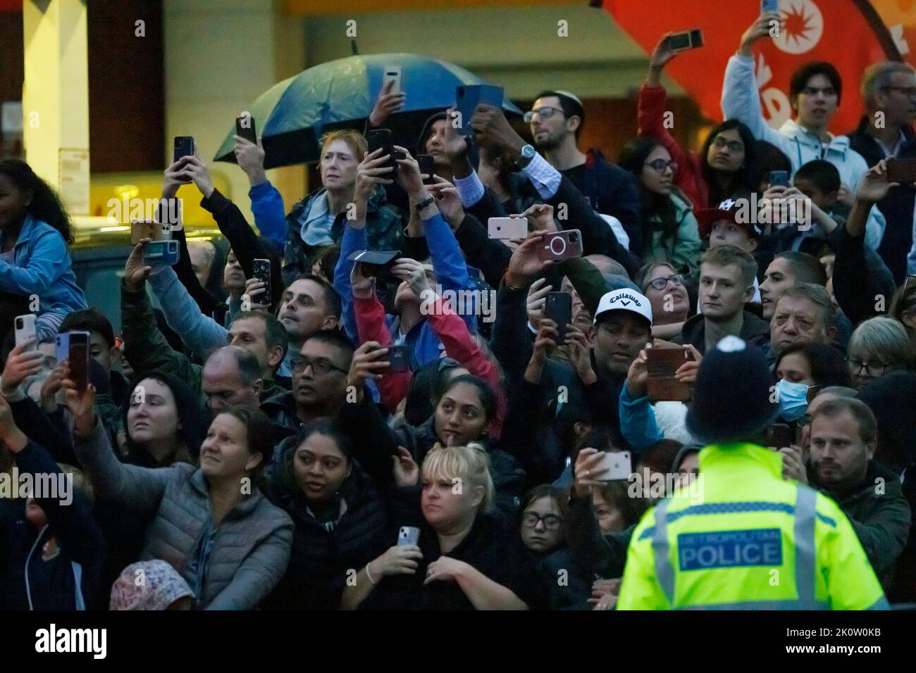 London, UK. 13th Sep, 2022. Members of the public clamber to watch and ...