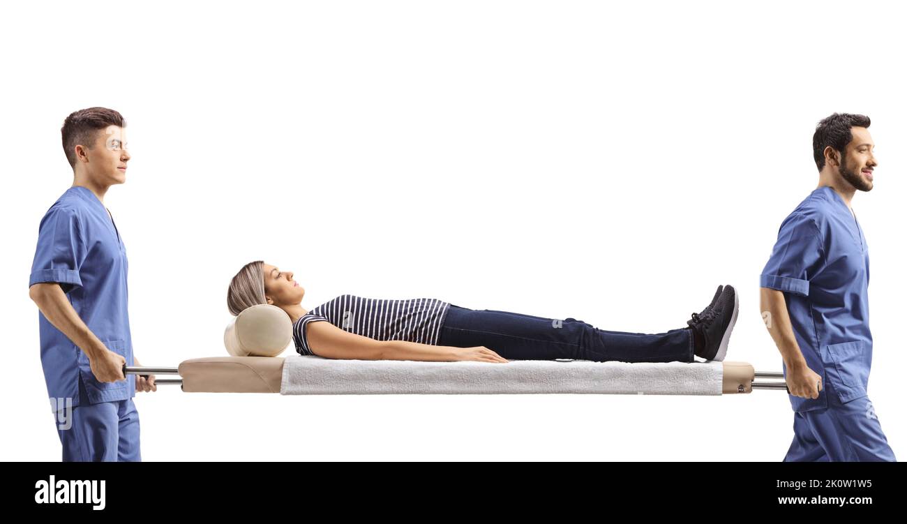 Medical workers carrying a stretcher with a female patient isolated on ...