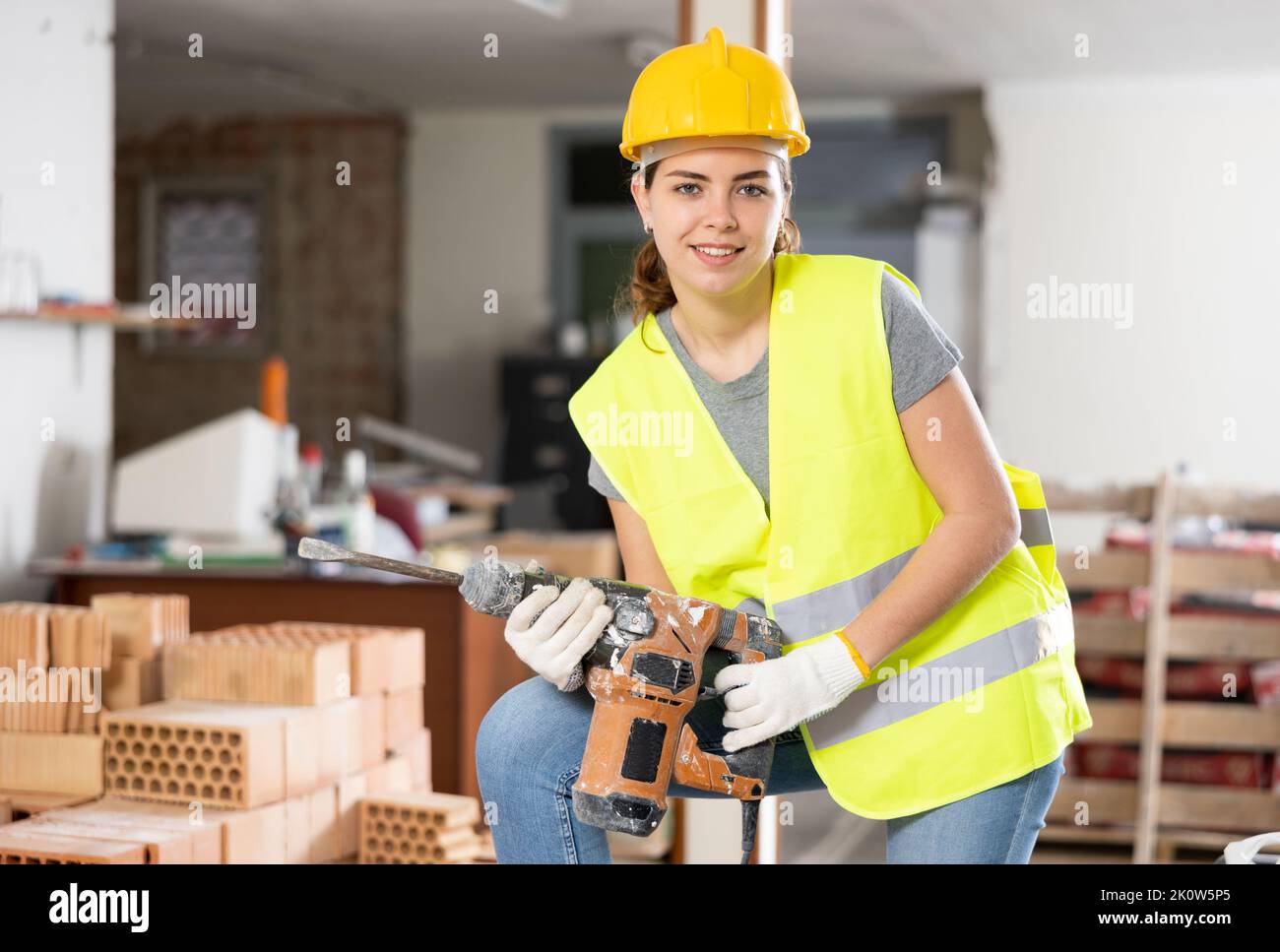 Female builder posing on indoor construction site Stock Photo - Alamy