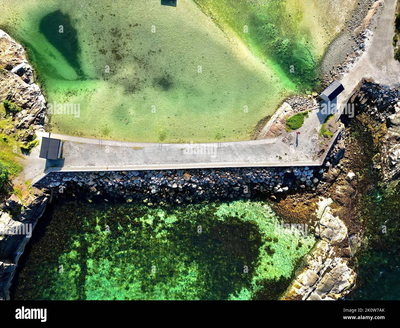 an aerial of a stone dock surrounded by greenish waters in the ...
