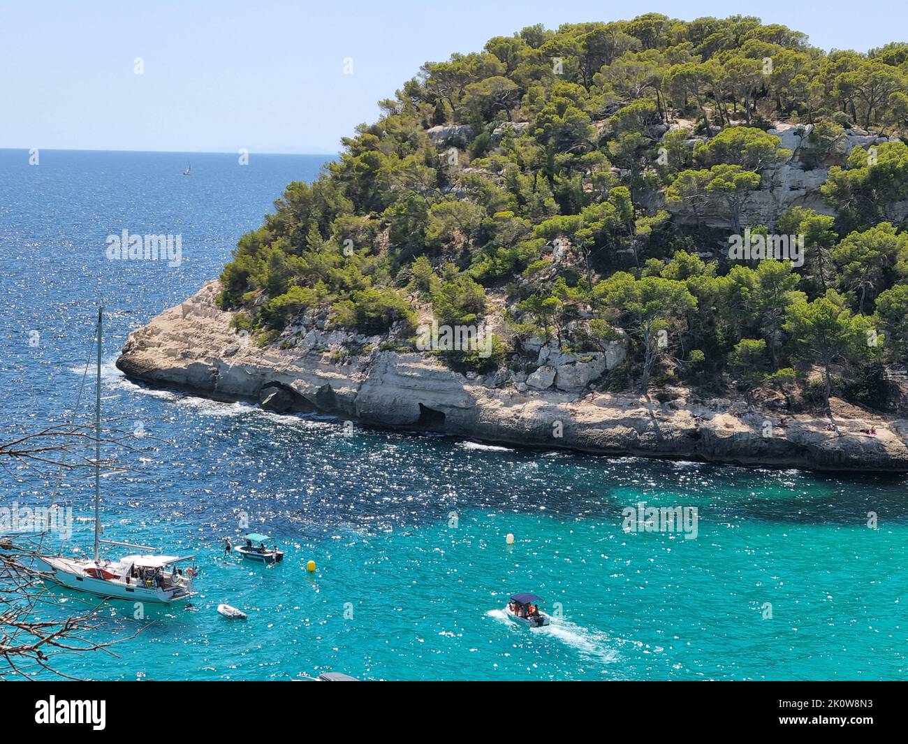 View of turquoise sea in beautiful bay Cala Mitjaneta in Menorca Stock ...