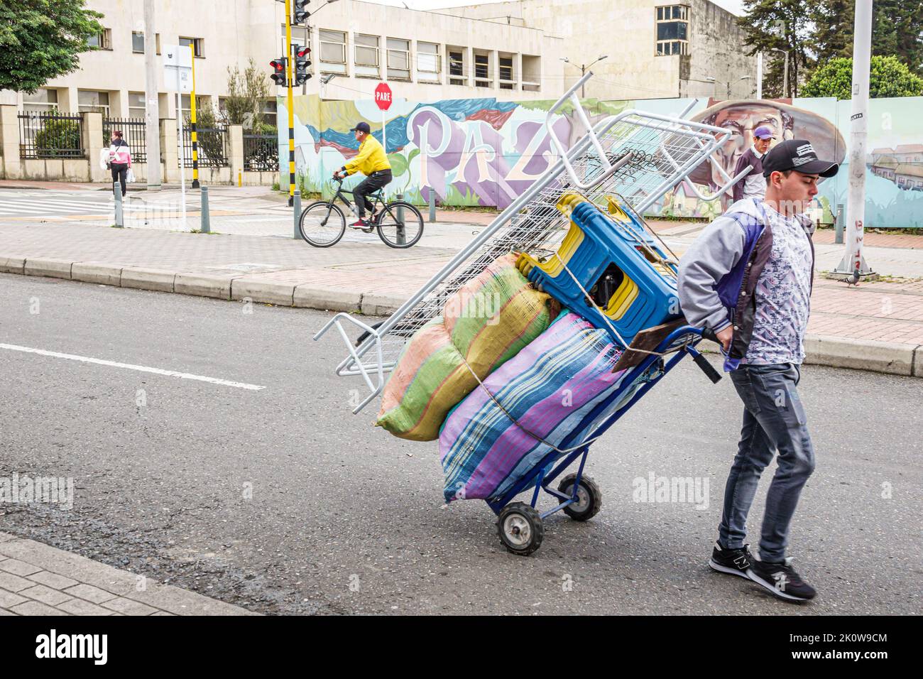 Delivery man pulling cart loaded hi-res stock photography and images ...