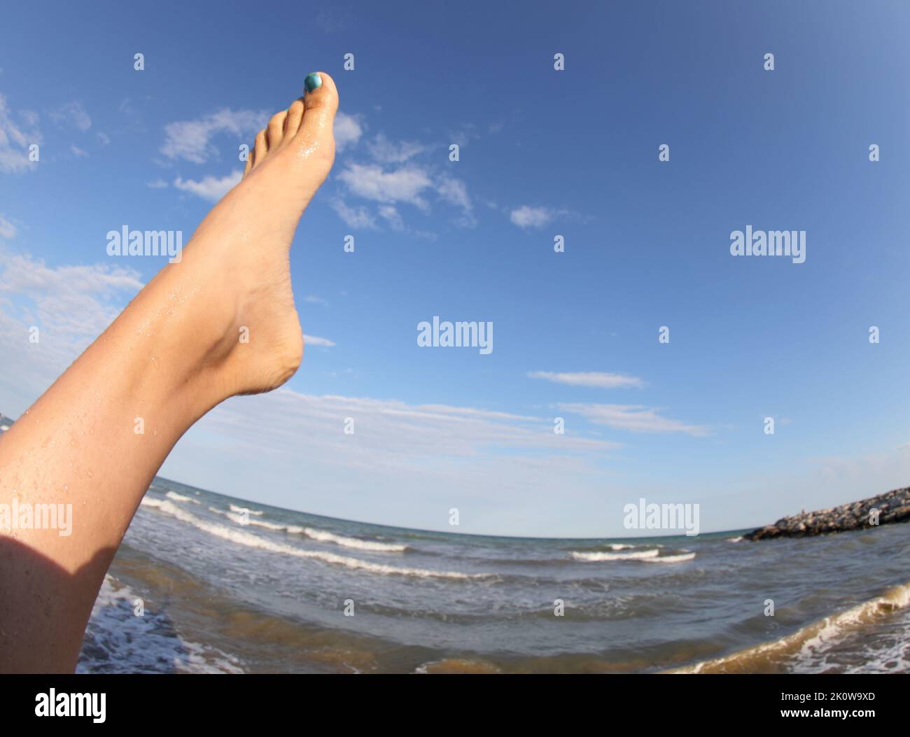 barefoot foot with sea background in summer photographed with fish eye ...