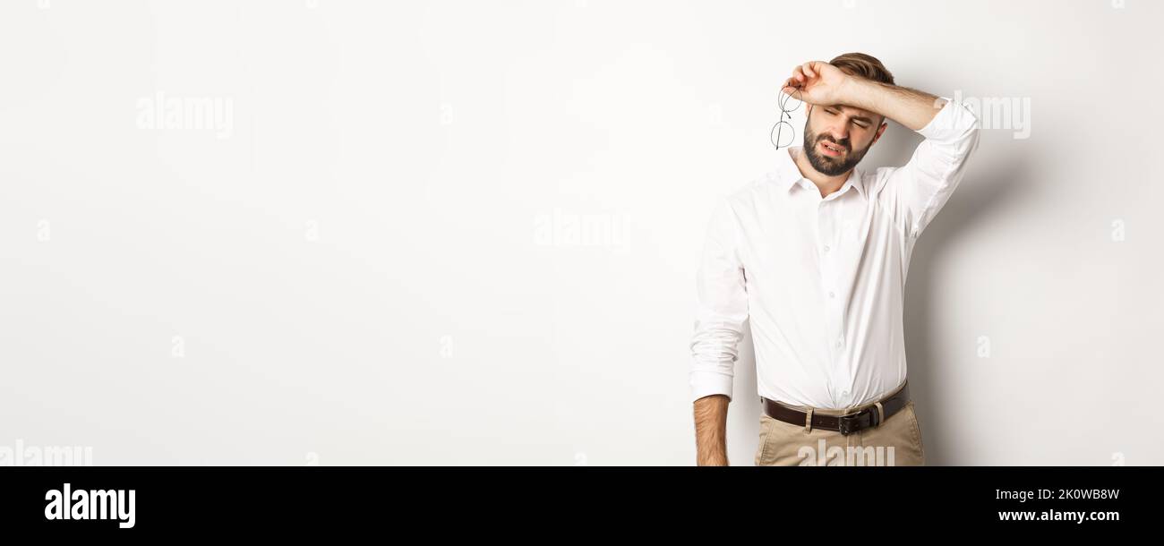 Tired office worker take-off glasses, wiping sweat off forehead with ...
