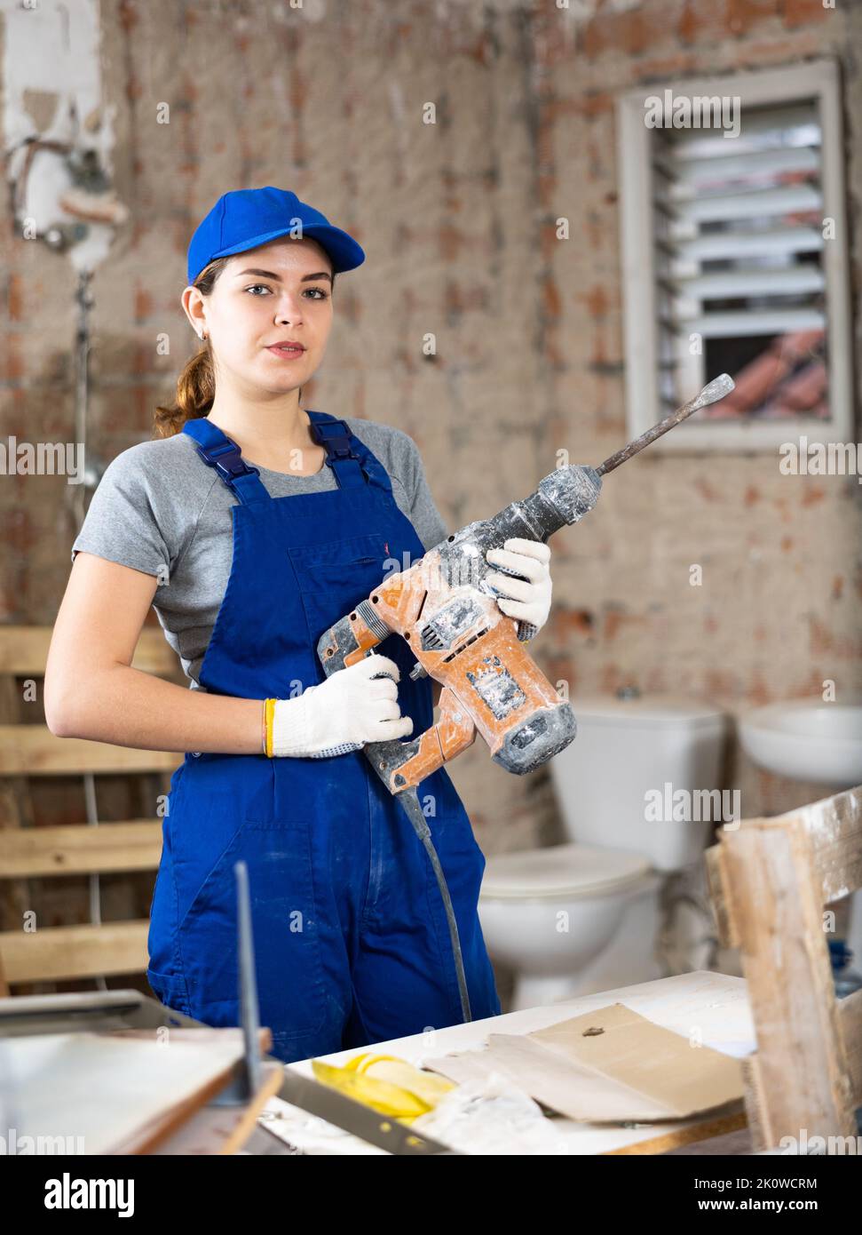 Female worker posing on indoor construction site Stock Photo - Alamy