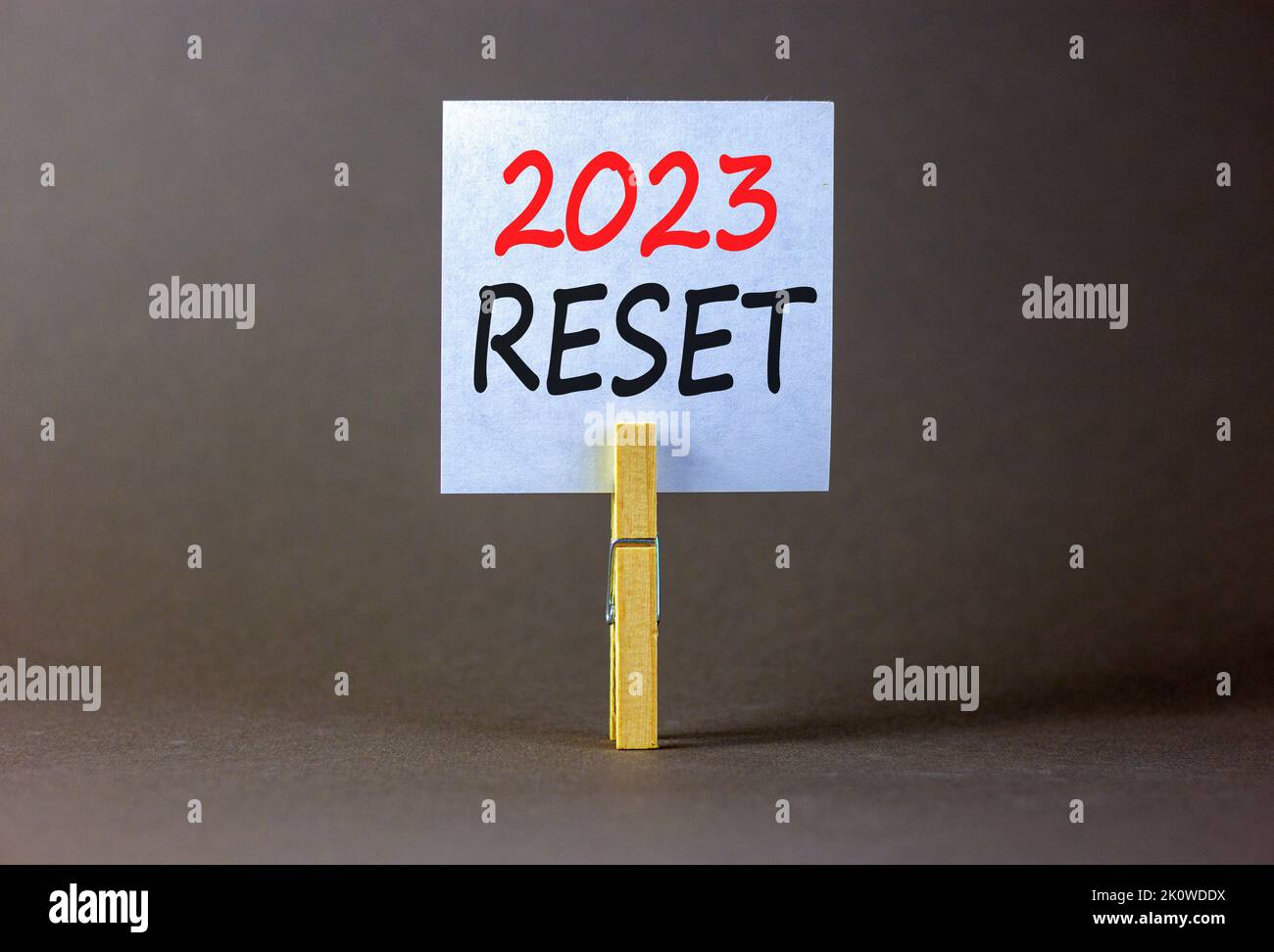2023 Reset symbol. White paper with words 2023 Reset, clip on wooden ...