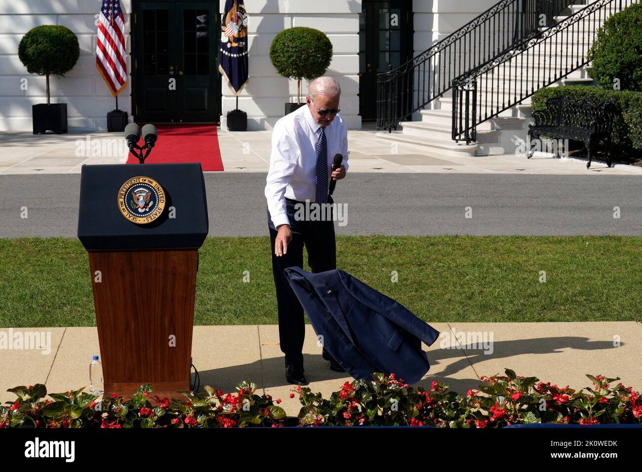 U.S. President Joe Biden drops his jacket at an event celebrating the ...