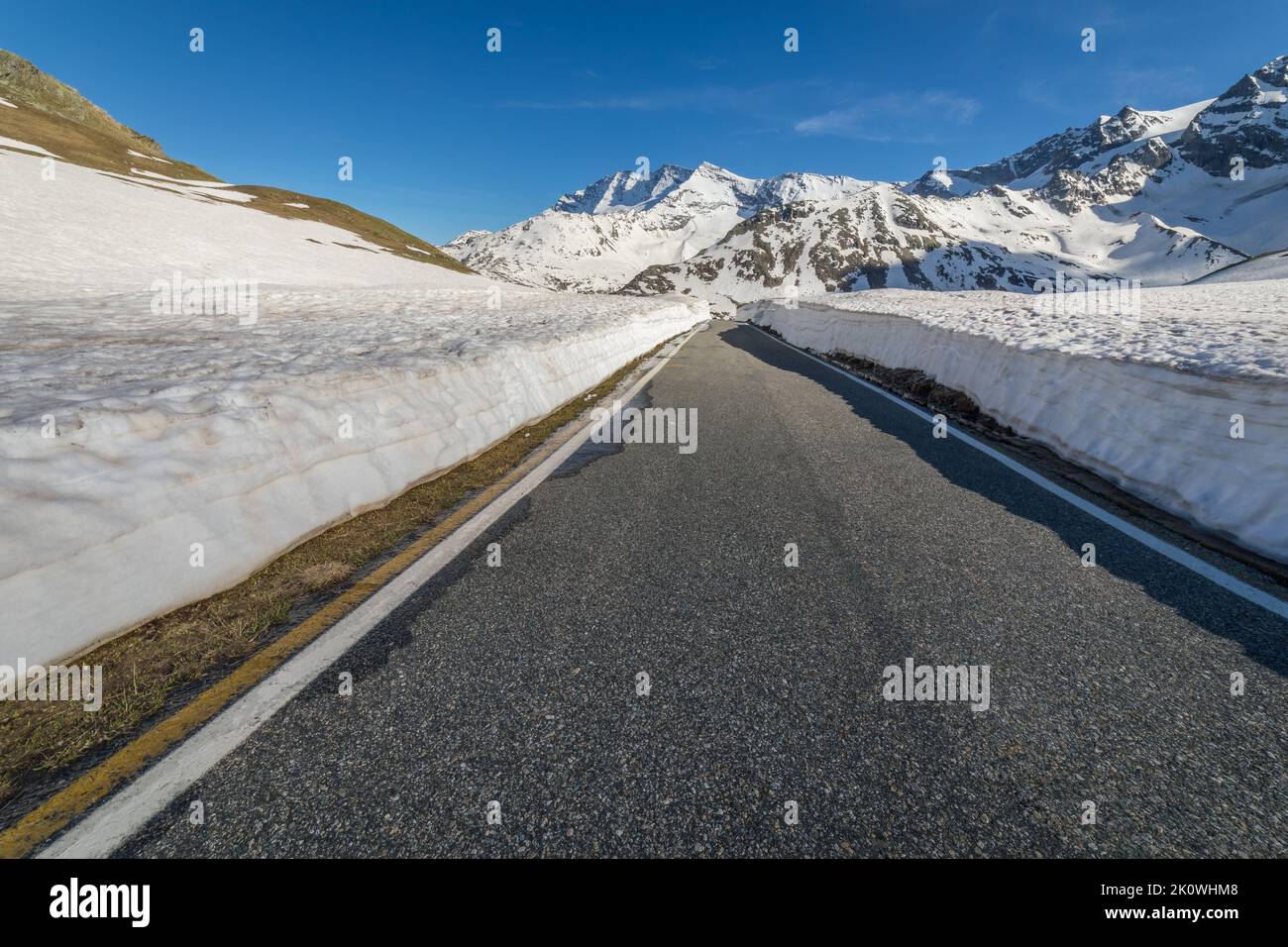 Alpine mountain road between snow at springtime, Gran Paradiso Alps ...