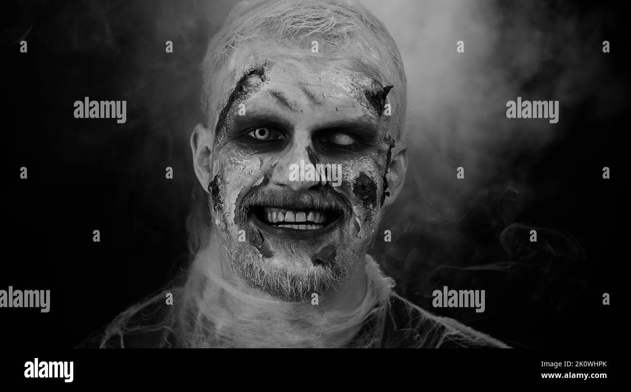 Creepy man with bloody scars face, Halloween stylish zombie make-up ...