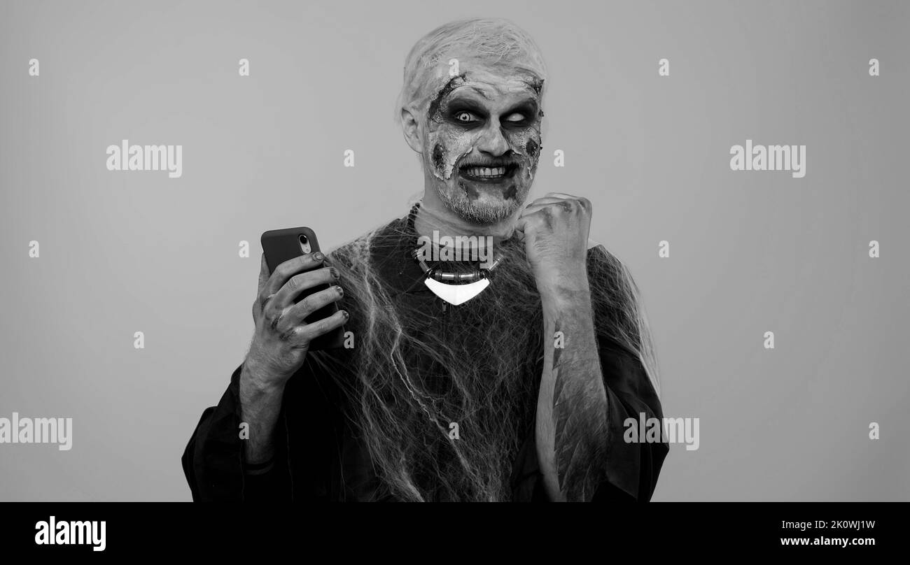 Happy excited sinister man in carnival costume of Halloween crazy ...