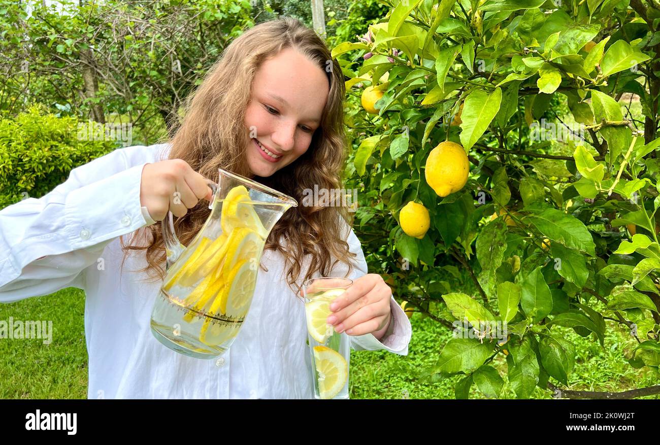 it's just a lemon paradise, a teenage girl stands against the backdrop ...
