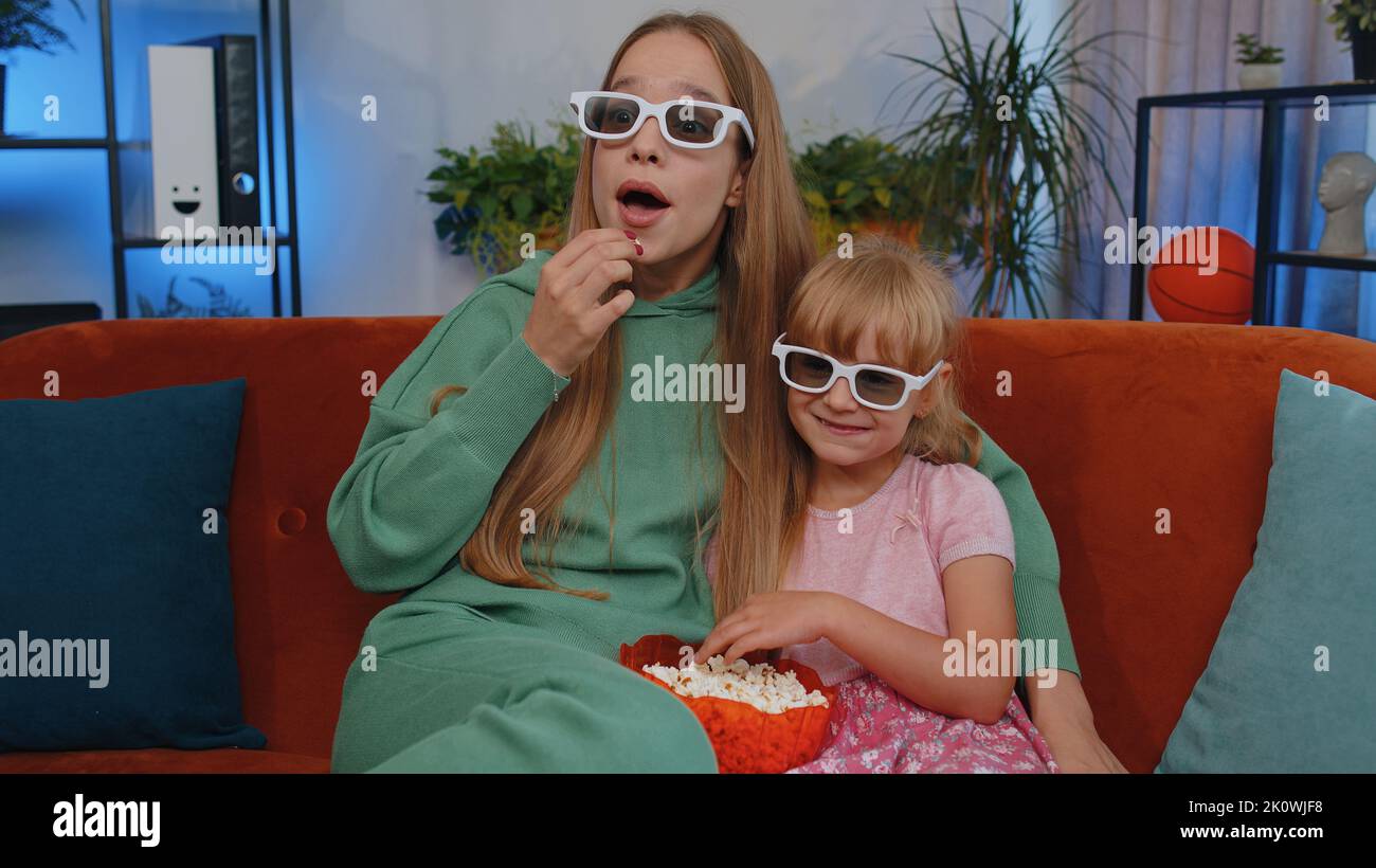 Girls friends siblings watching favorite tv show movie and eating ...