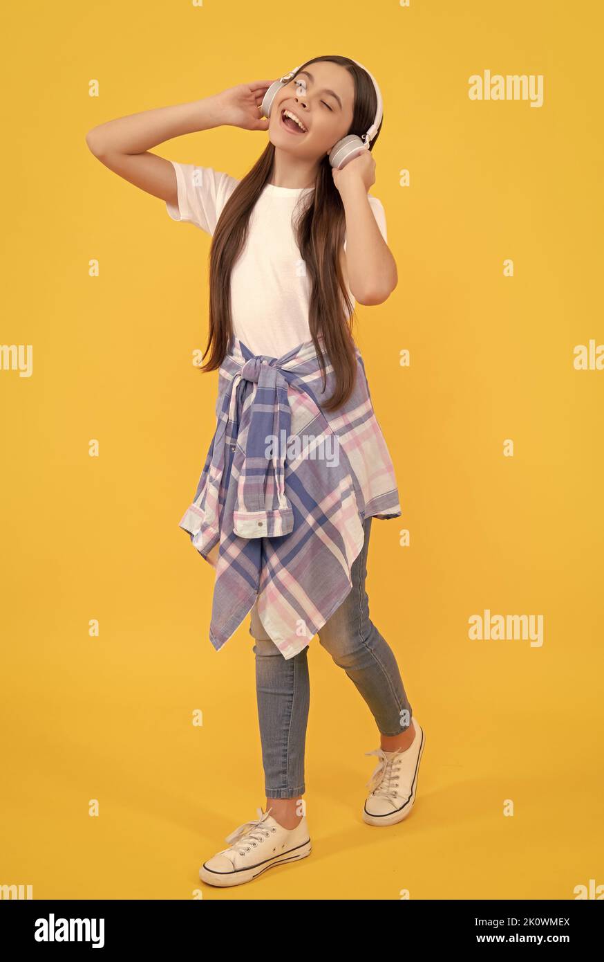 Happy kid in headphones enjoy singing song yellow background, music ...