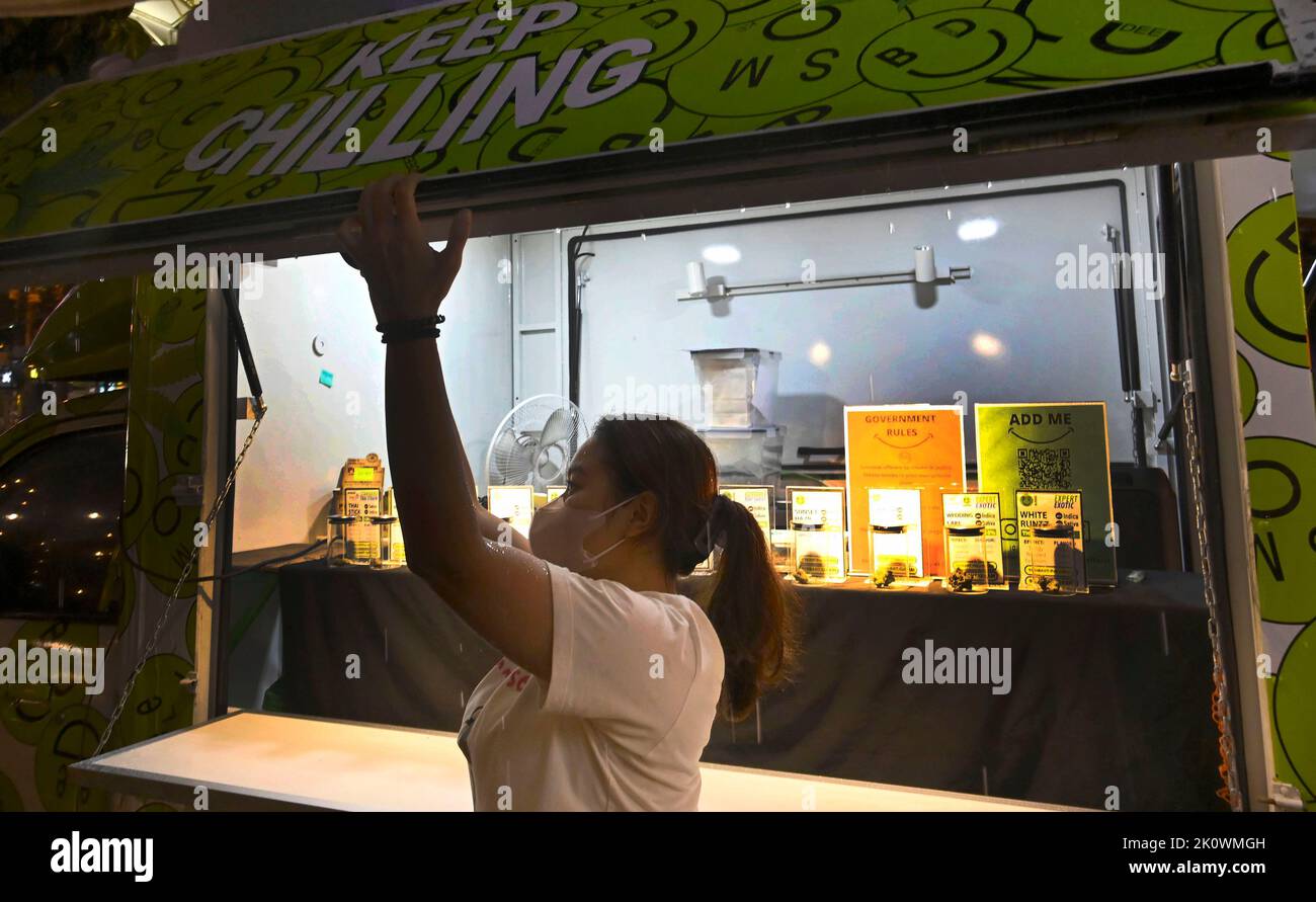 Bangkok, Thailand. 13th Sep, 2022. A Thai vendor adjusts the canopy of her " Buddee" pop-up ...