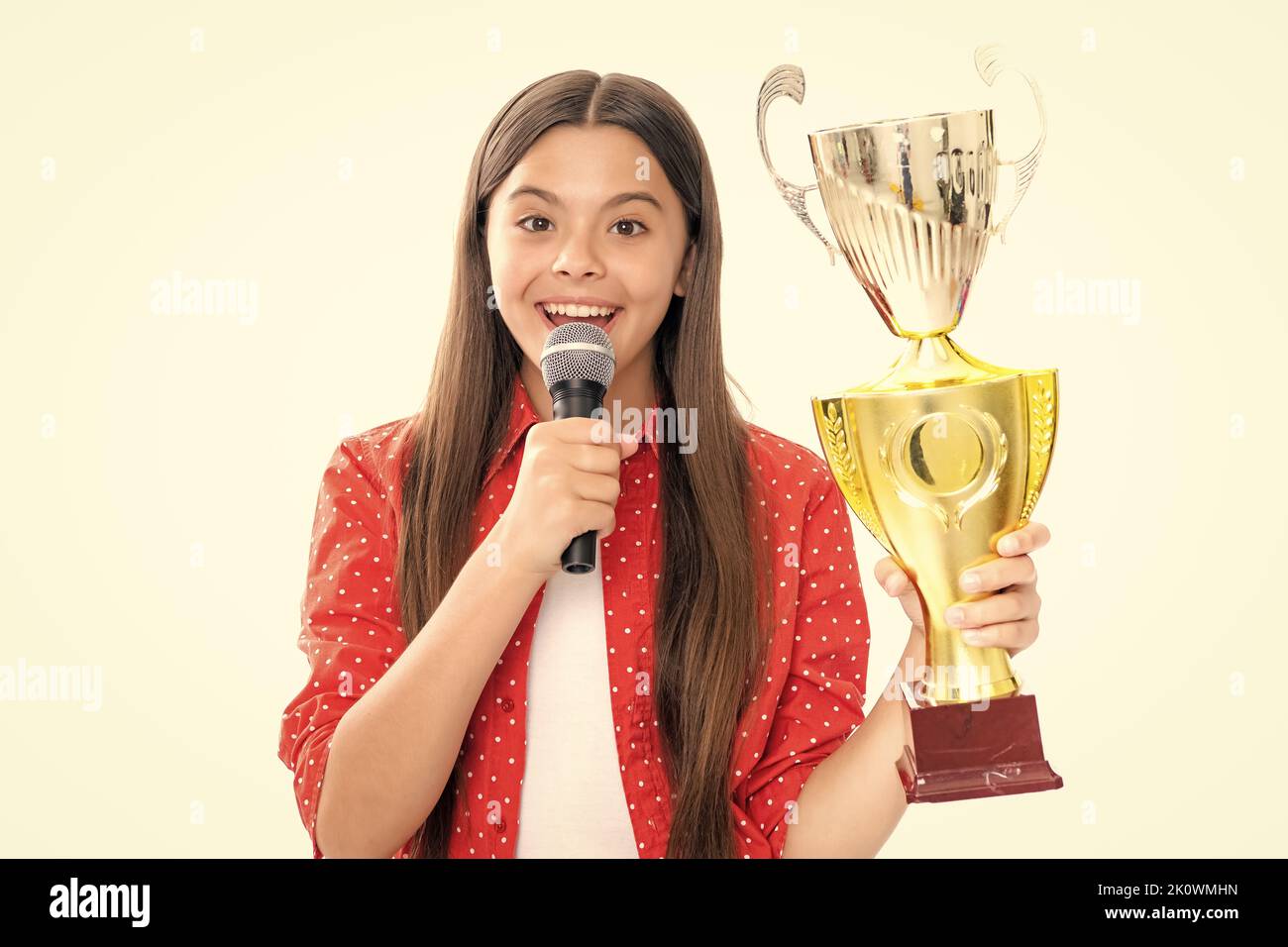Girl with win cup microphone speech. Teen holding a trophy. Kid winner ...