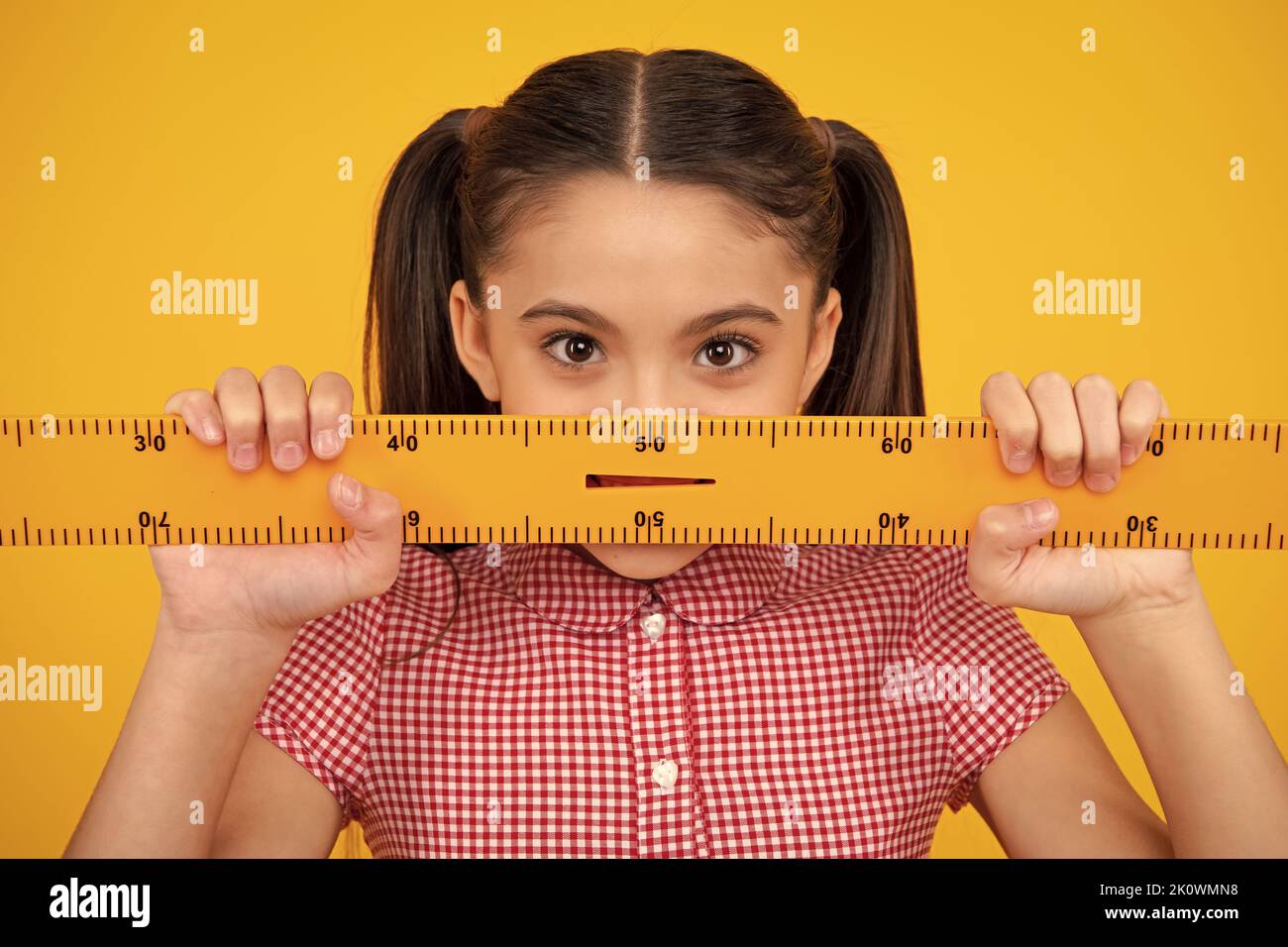 Teenager school girl study math or geometry lesson, measure the size ...