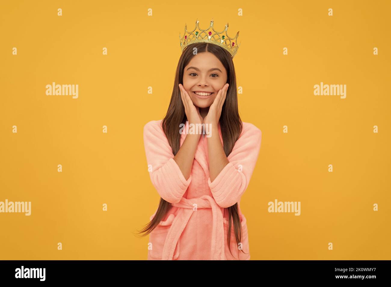 smug happy teen girl in home terry bathrobe and princess crown ...