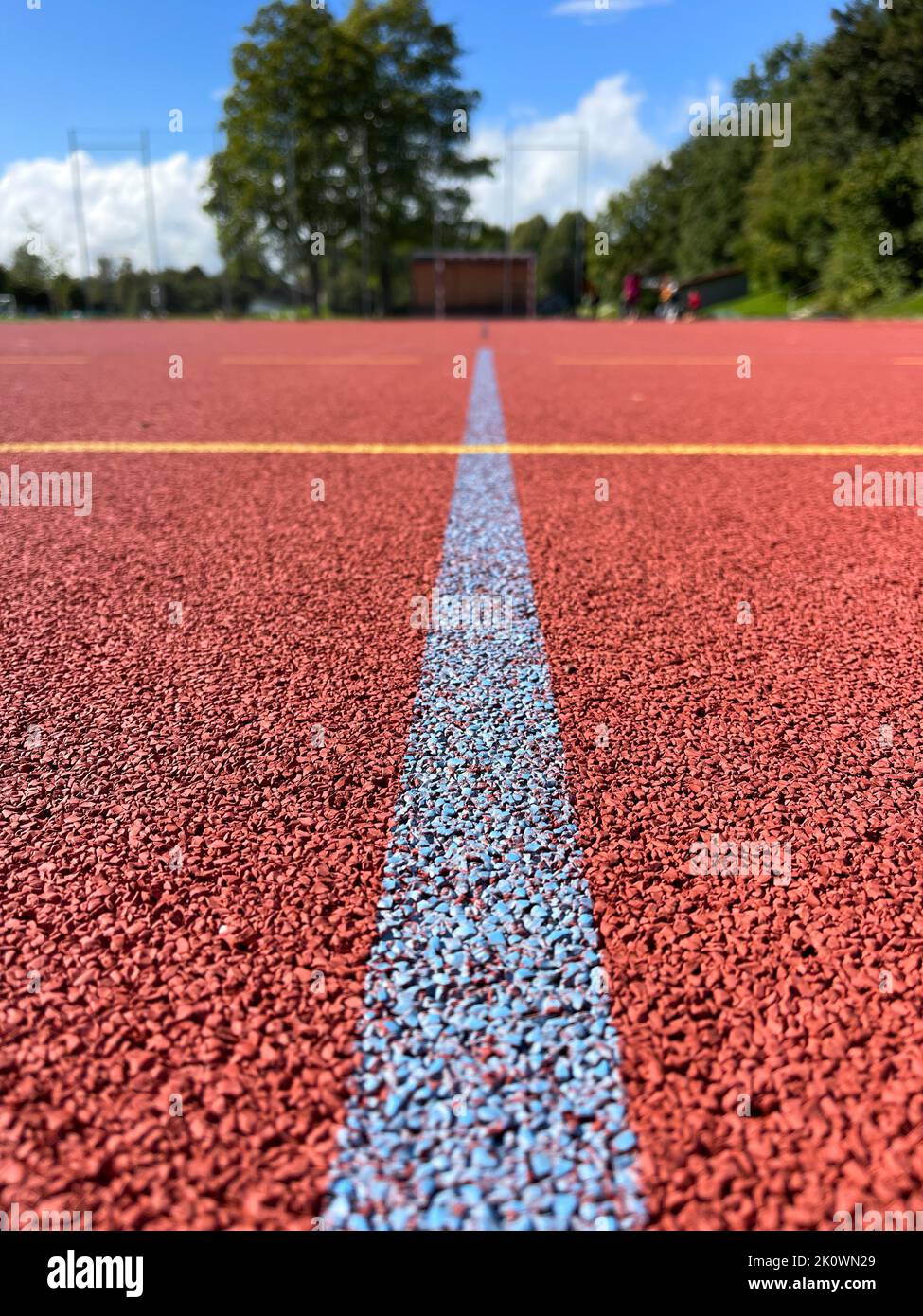 A closeup of a playground asphalt in a park with trees Stock Photo - Alamy