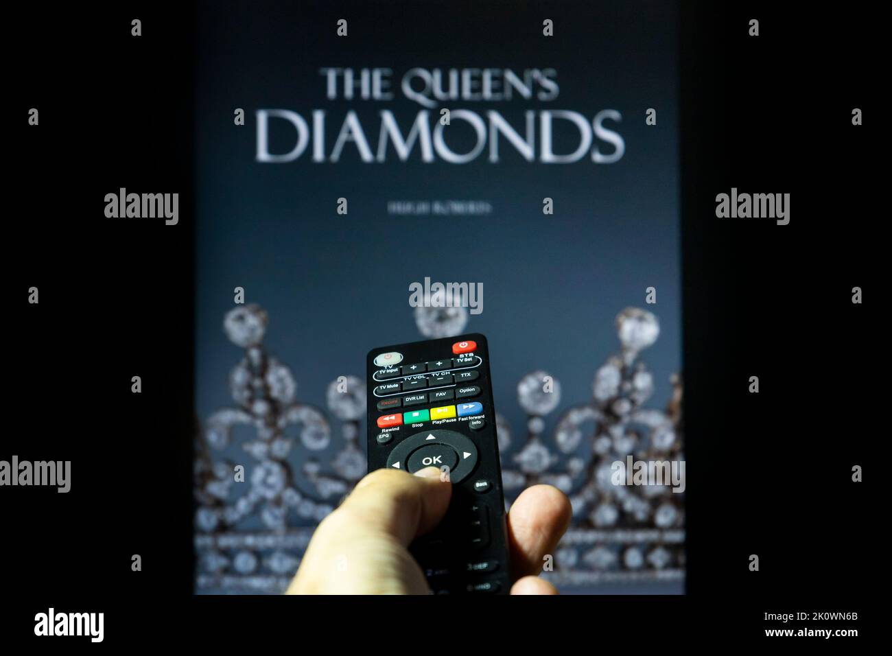Belgrade, Serbia - September 12, 2022: The Queens Diamonds book cover on tv screen with remote ...