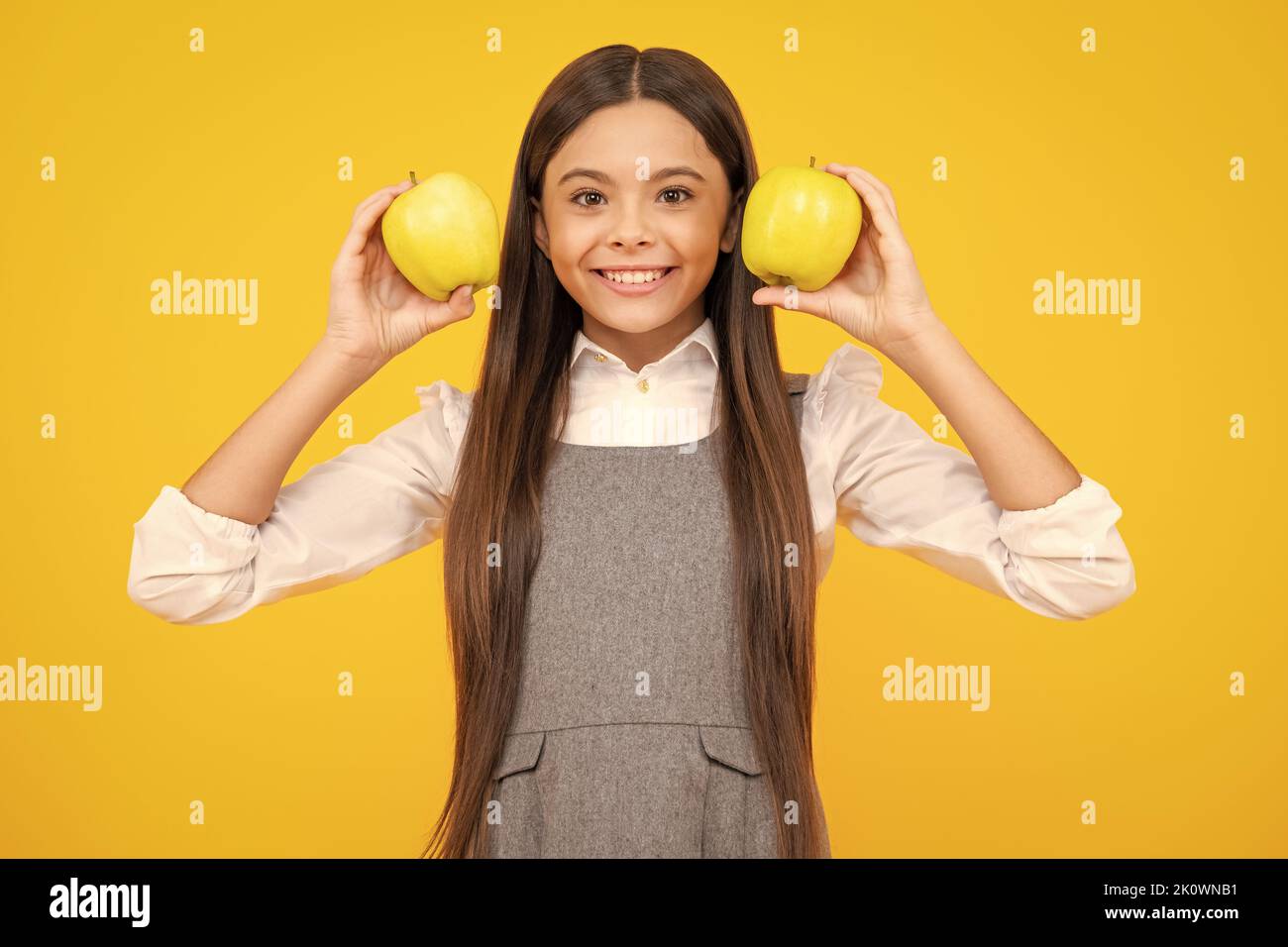 Teen girl child with apple, isolated portrait Stock Photo - Alamy