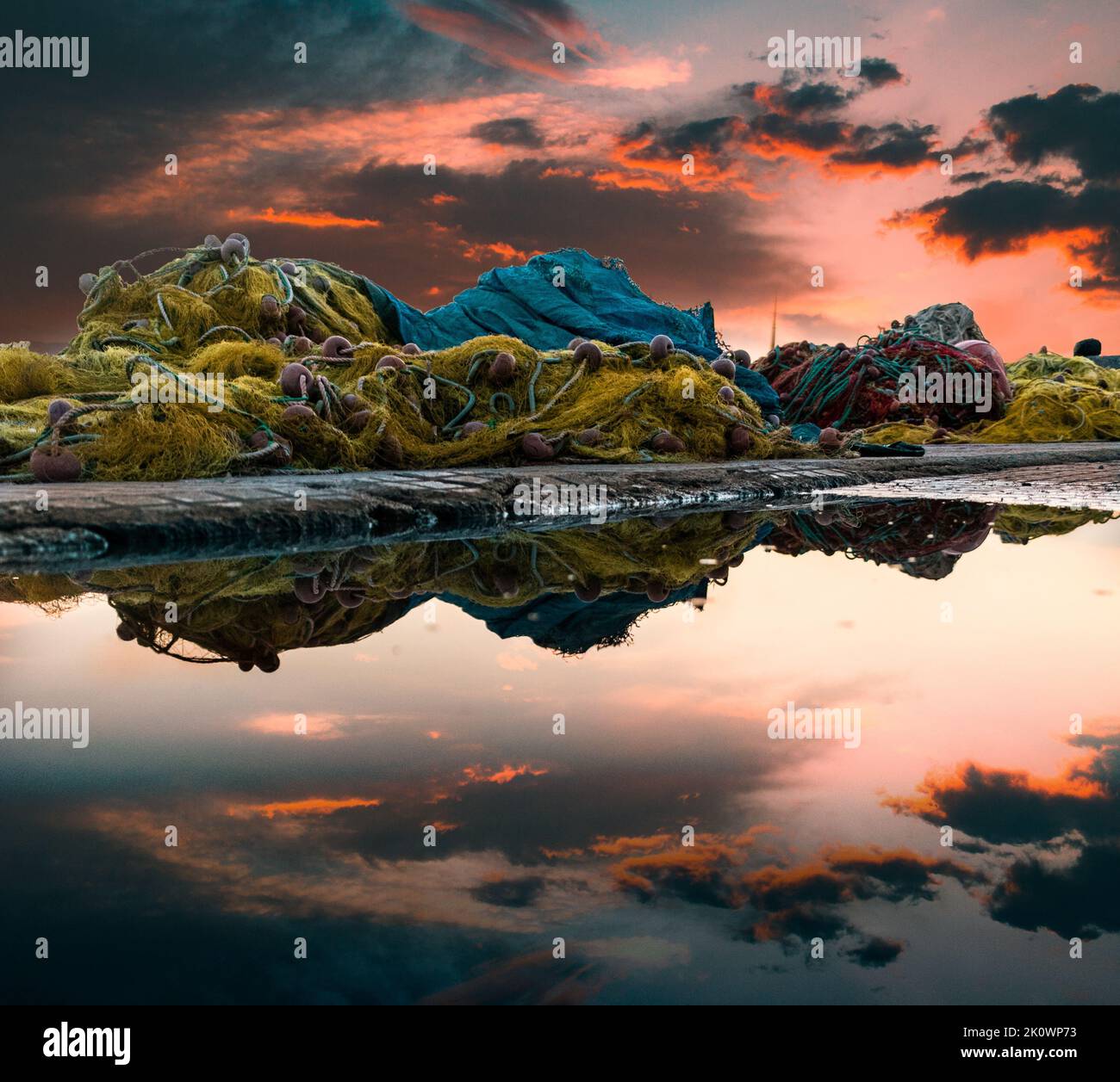 The fishing net reflections on water during sunset Stock Photo - Alamy