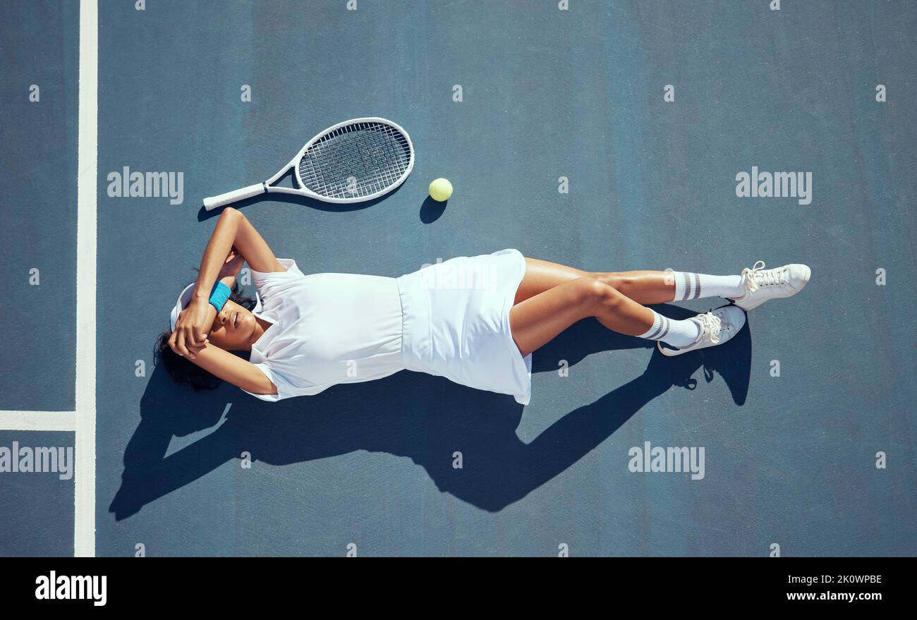Woman tennis athlete tired and exhausted after training, exercise or ...